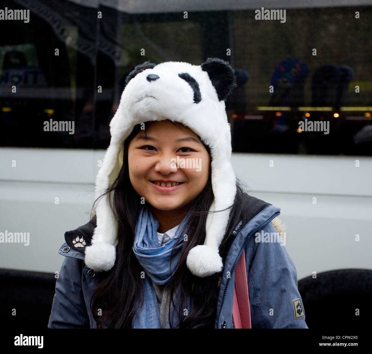 Tourist wearing a panda hat Stock Photo - Alamy