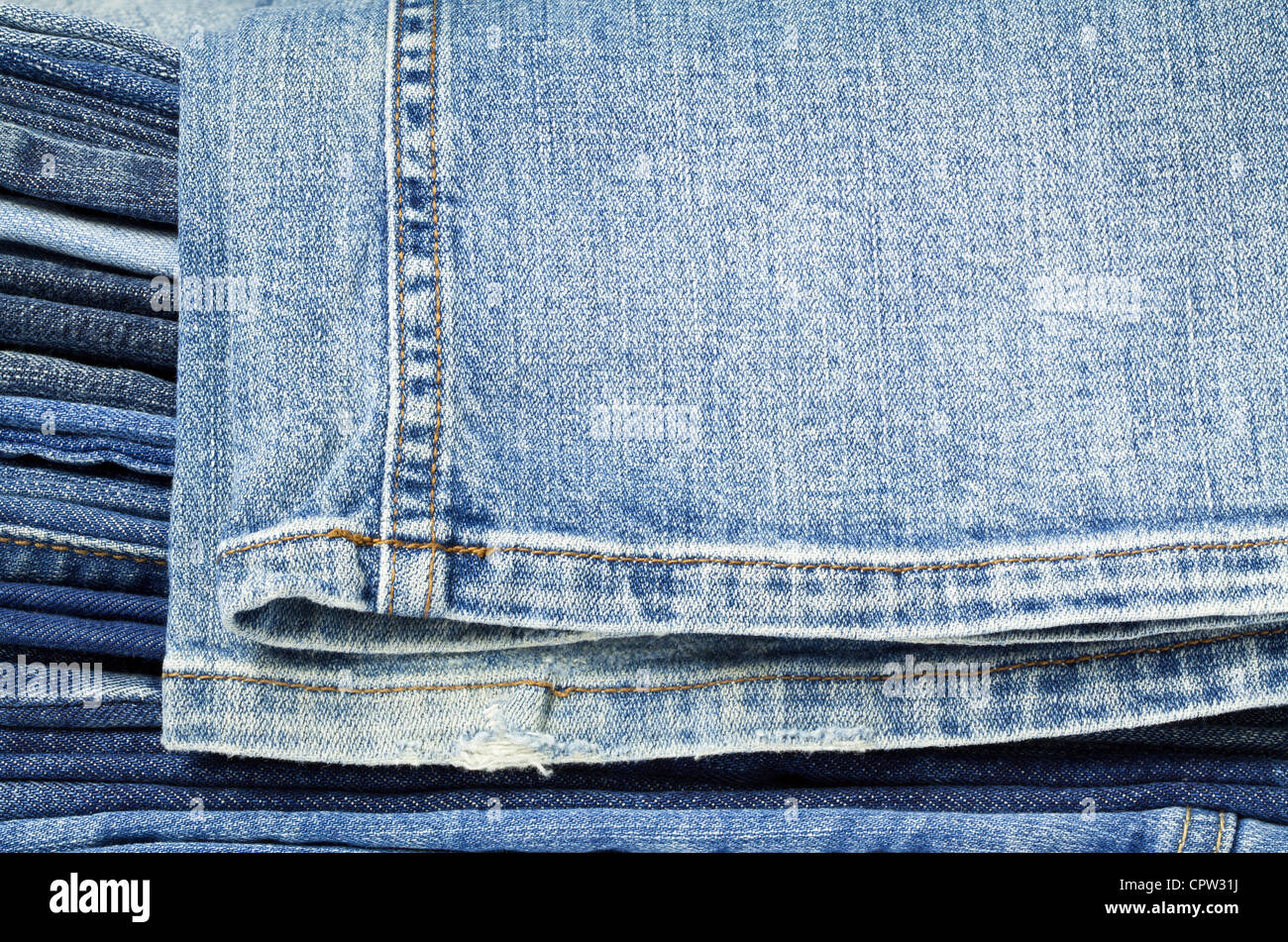 Jeans trousers stack with a leg closeup Stock Photo - Alamy