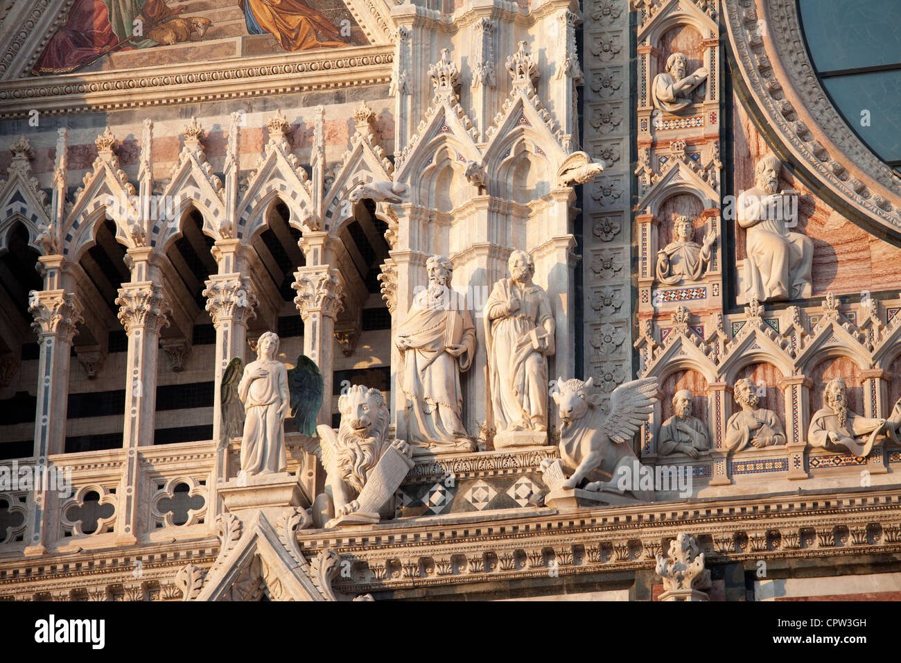 Detail of religious statues and gargoyles on Il Duomo di Siena, the ...