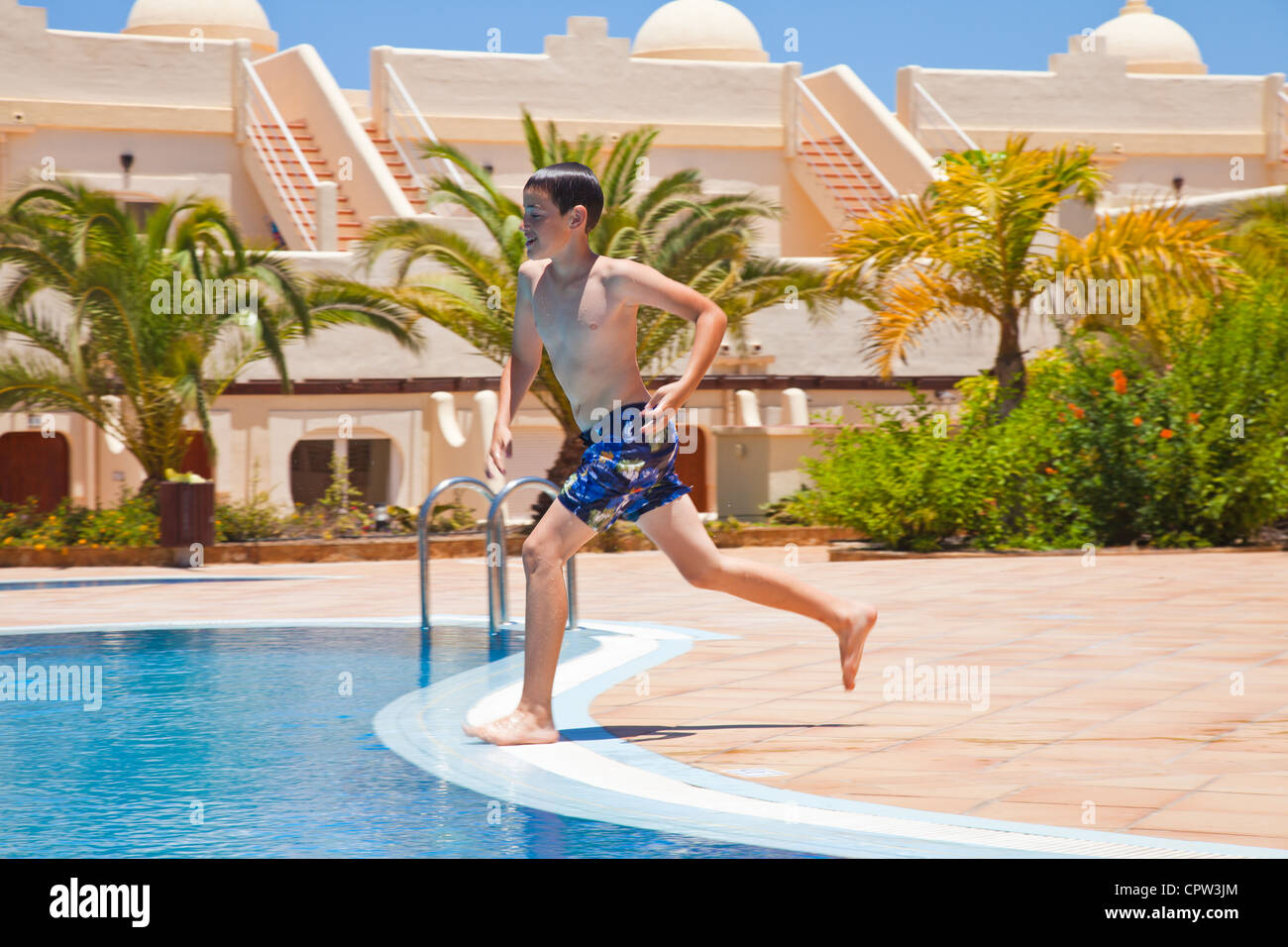 a boy jumps into a swimmimg pool; some motion blur Stock Photo - Alamy