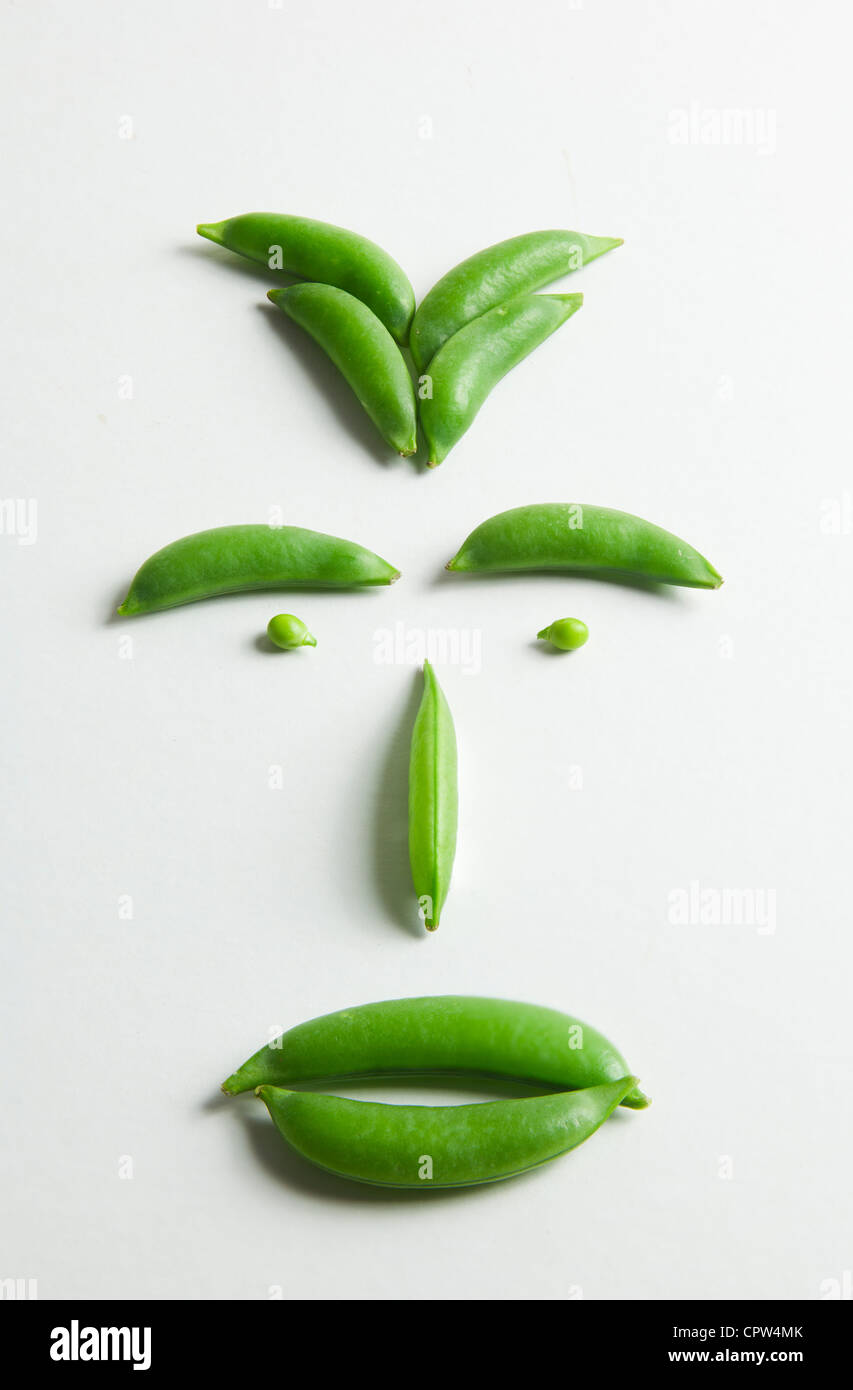 Face made of sugar snap peas isolated on white background Stock Photo ...