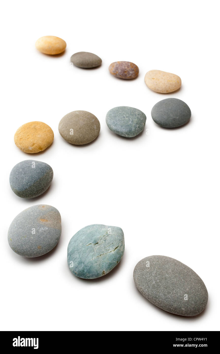 Snaking line of twelve coloured pebbles isolated on white. Clipping ...