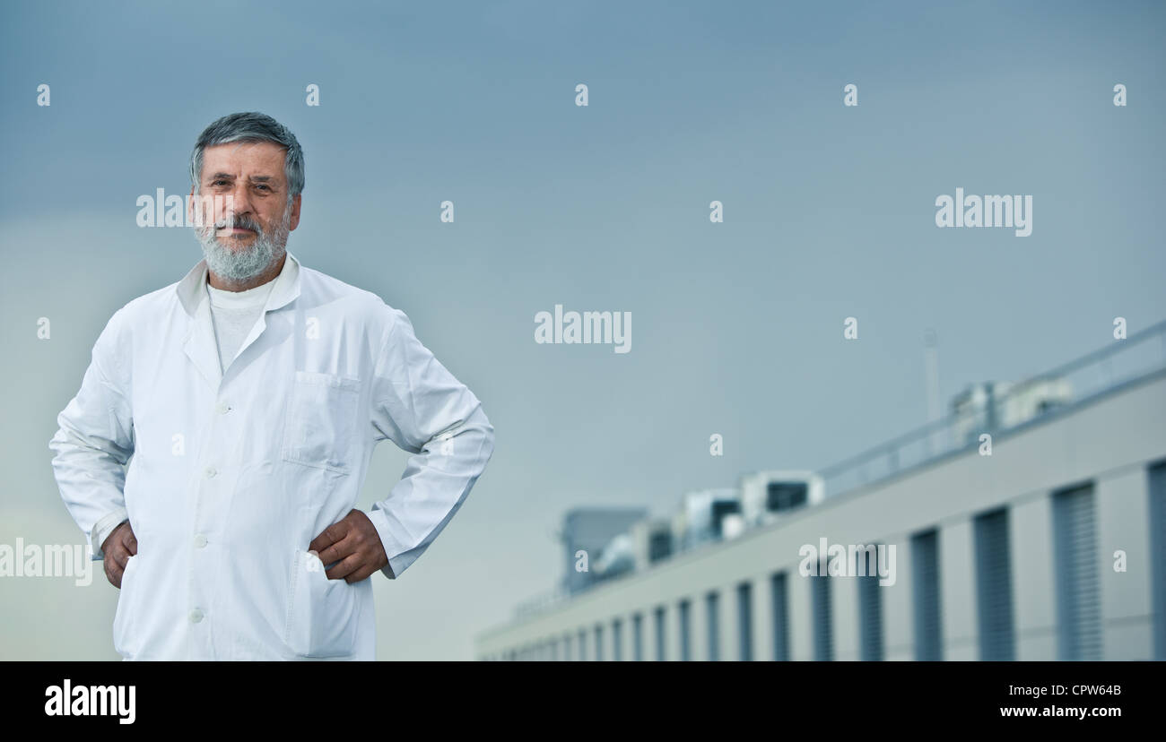 renowned scientist/doctor standing on the roof of the research center ...