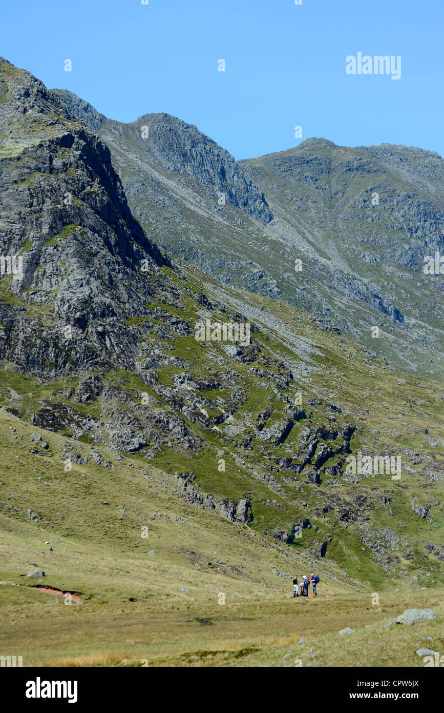 Walkers approaching Crinkle Crags from Red Tarn. Lake District National ...