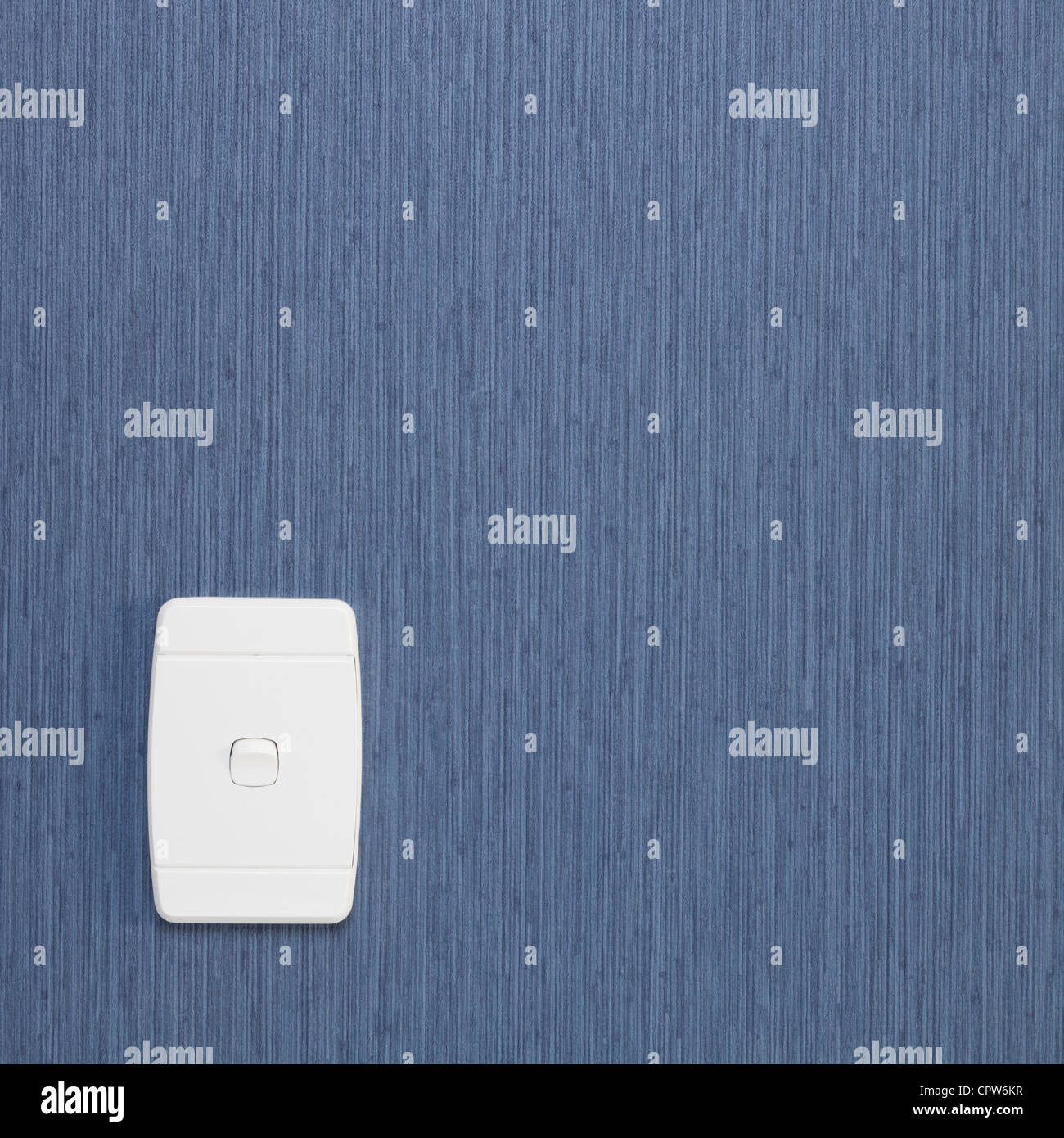 Single gang electrical light switch on wall with blue textured ...