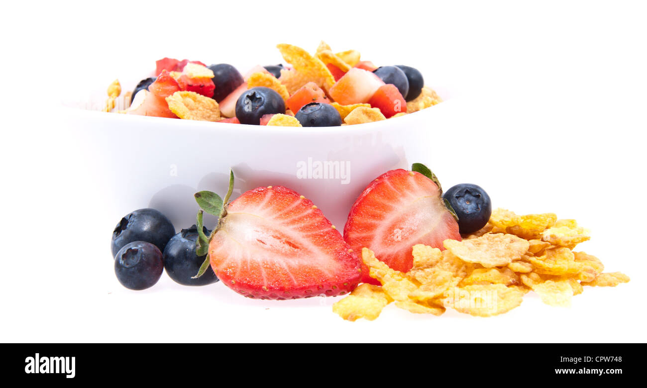 Cornflakes with fresh fruits in a bowl isolated on white background ...