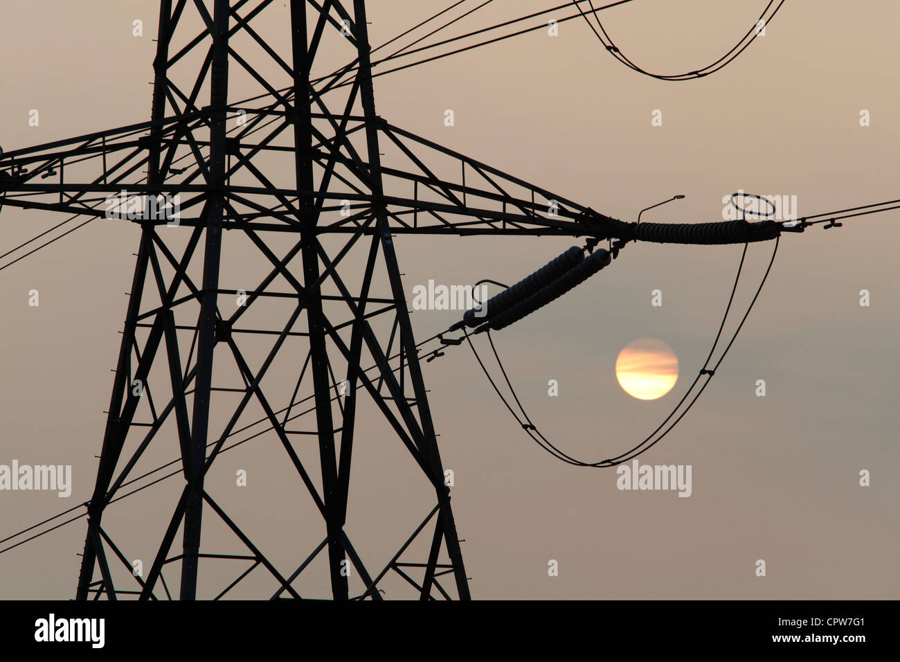 Electricity pylons in the sunset hi-res stock photography and images ...