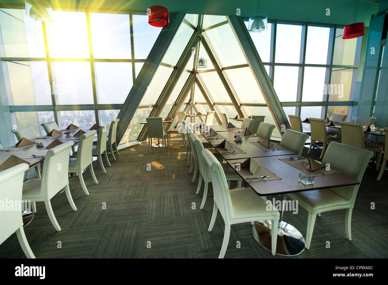 Tables, chairs and cutlery for celebration on the long table inside of ...