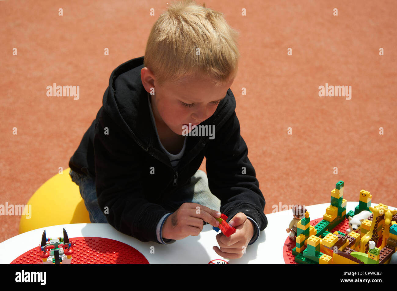 Child boy playing with building bricks Stock Photo - Alamy