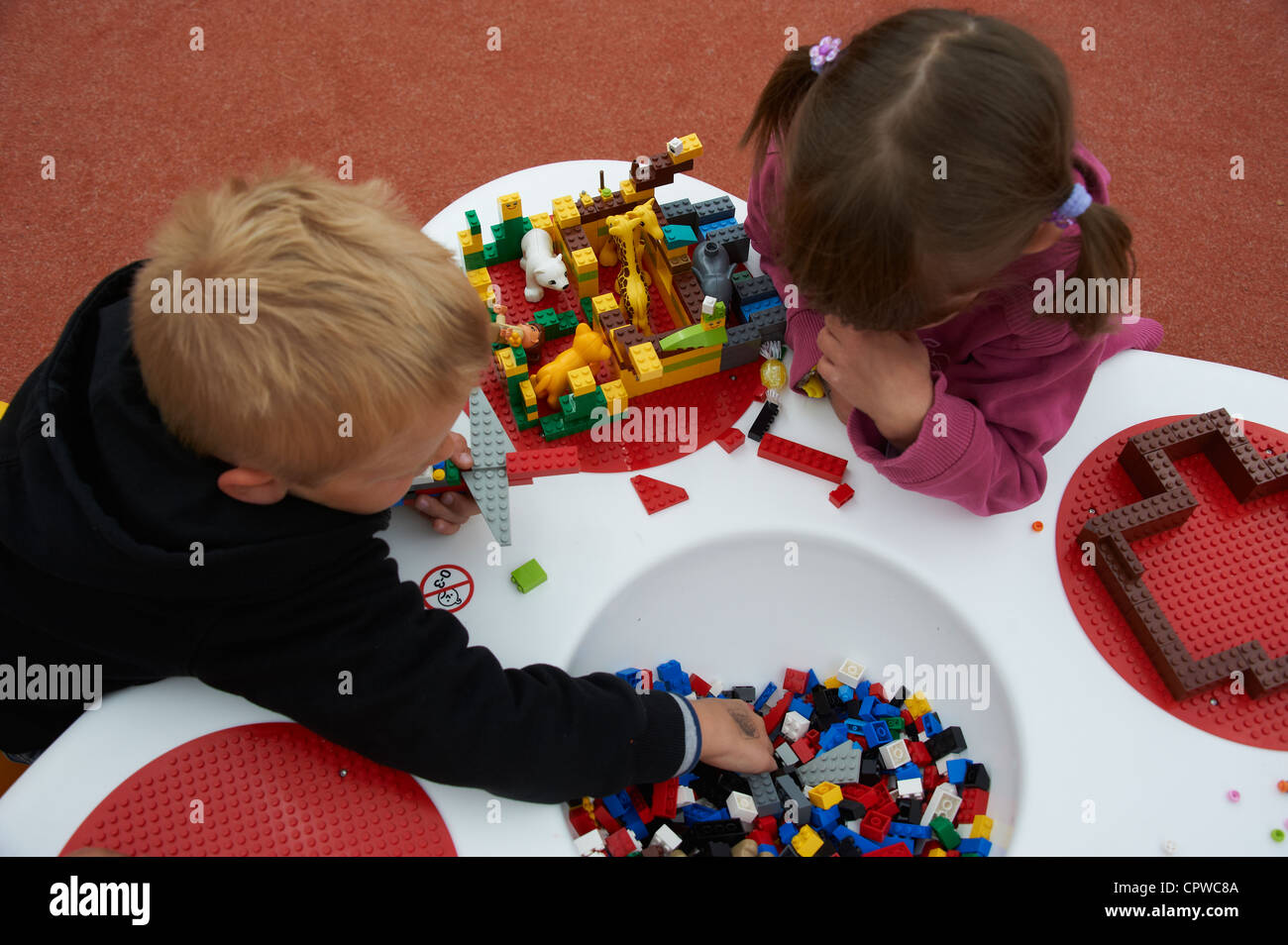 Children boy and girl playing with building bricks Stock Photo - Alamy