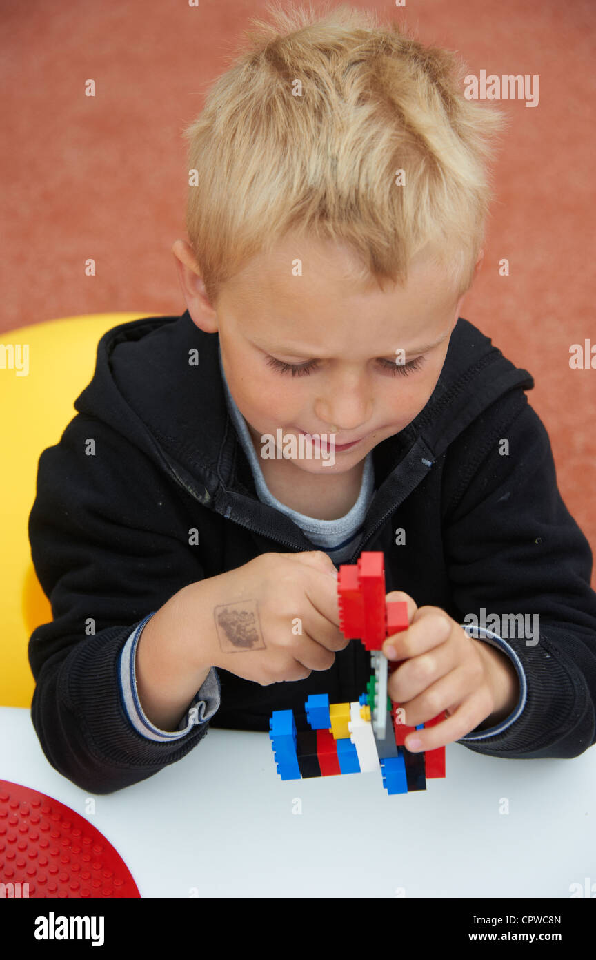 Child boy playing with building bricks Stock Photo - Alamy