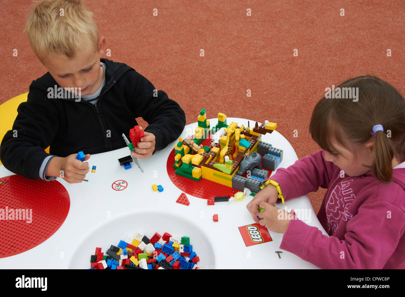 Children boy and girl playing with building bricks Stock Photo - Alamy