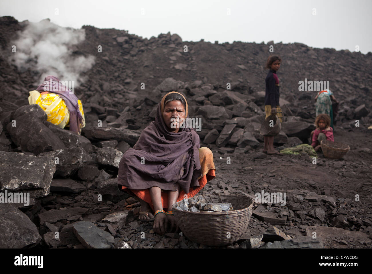 Woman collecting coal at mine scrap place, Jharia, Dhanbad, Jharkhand ...