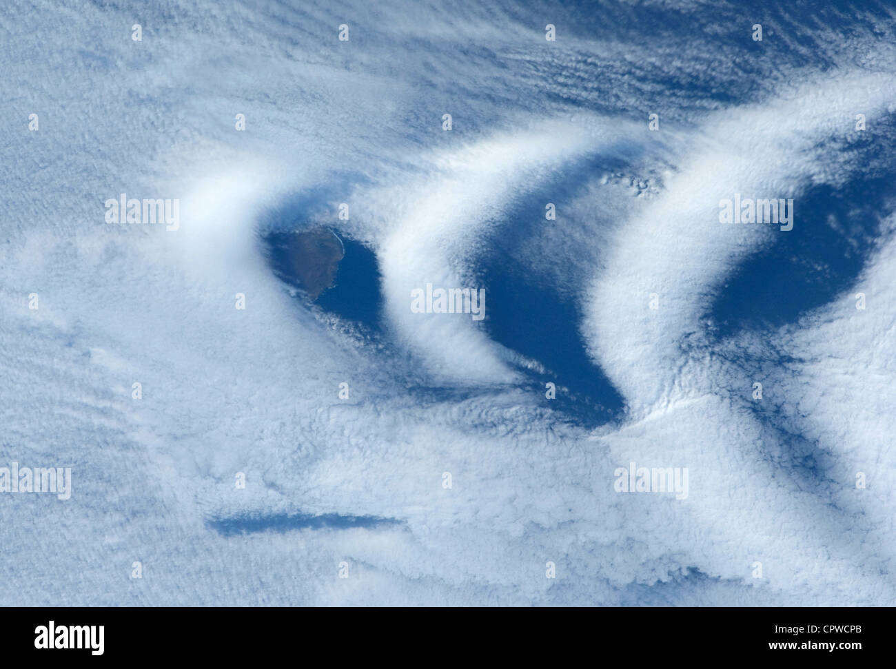 The formation of wave clouds in the wake, or downwind side, of Île aux ...
