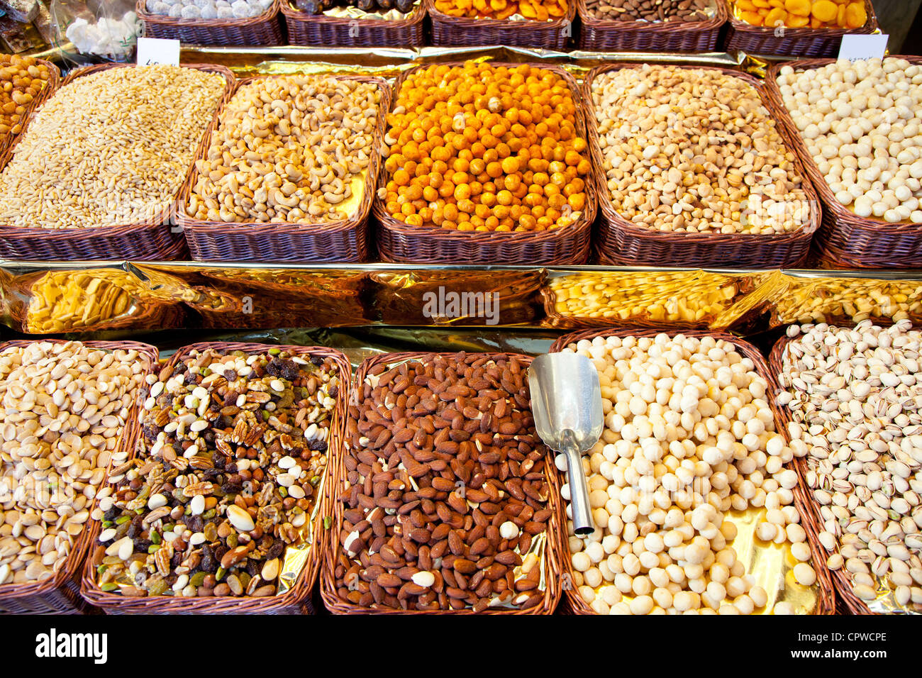 Dried nuts at market display in a row almonds peanuts Stock Photo - Alamy
