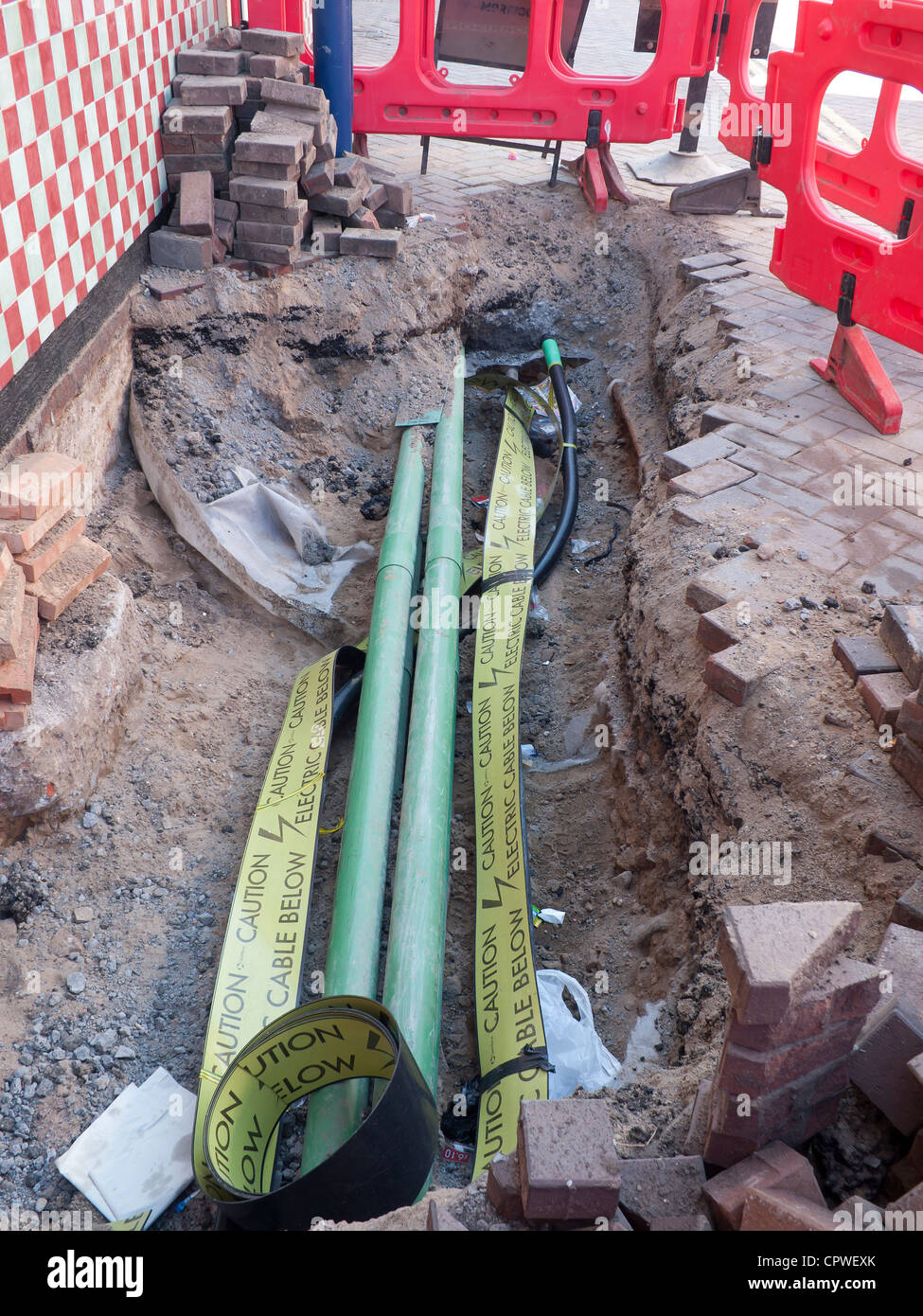 Excavation to expose electrical power cables for repair Stock Photo - Alamy