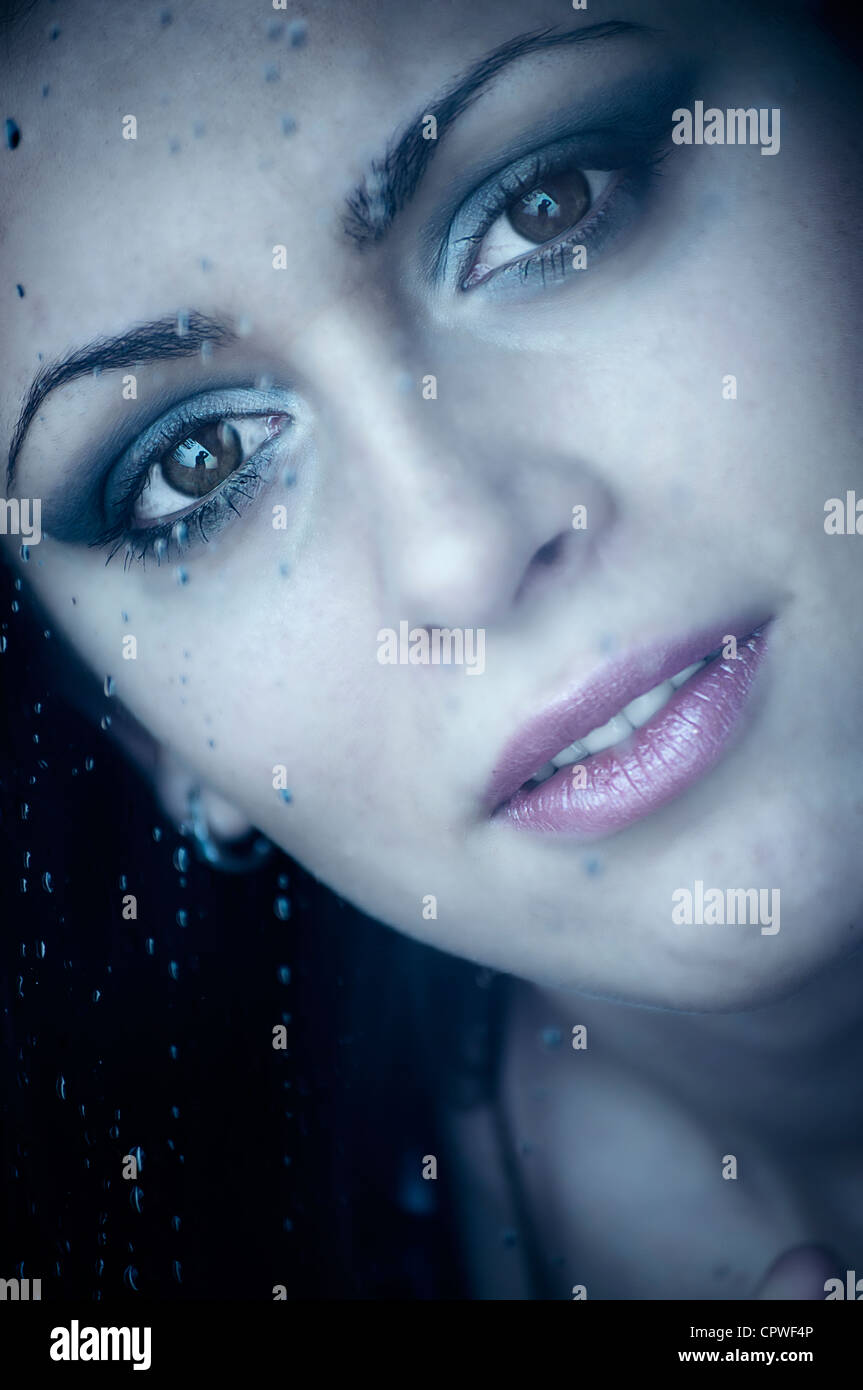 girl smiling through the window, after a rain. Portrait Stock Photo - Alamy