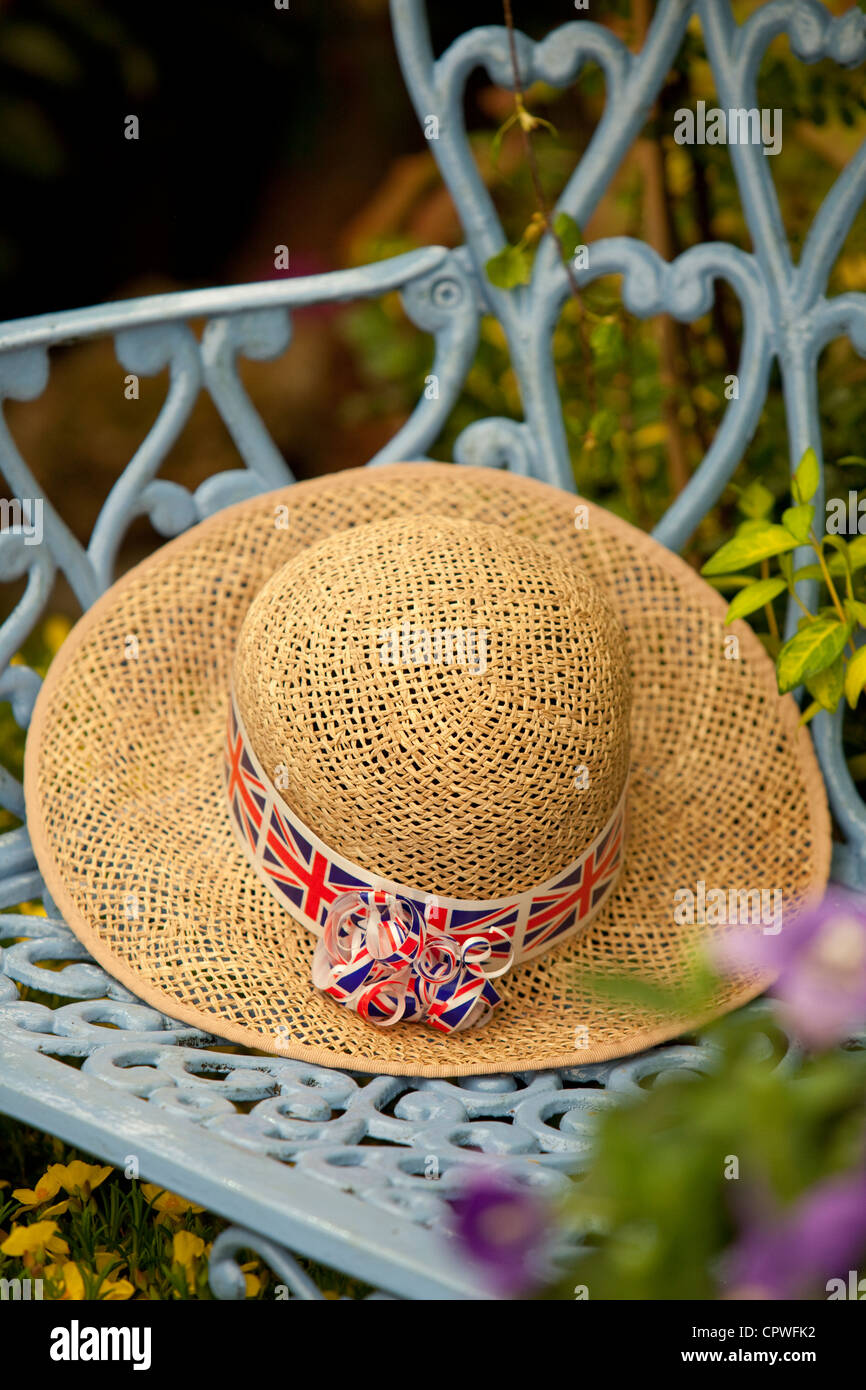 Lady's straw hat with Union Jack band in a country garden, England, UK ...