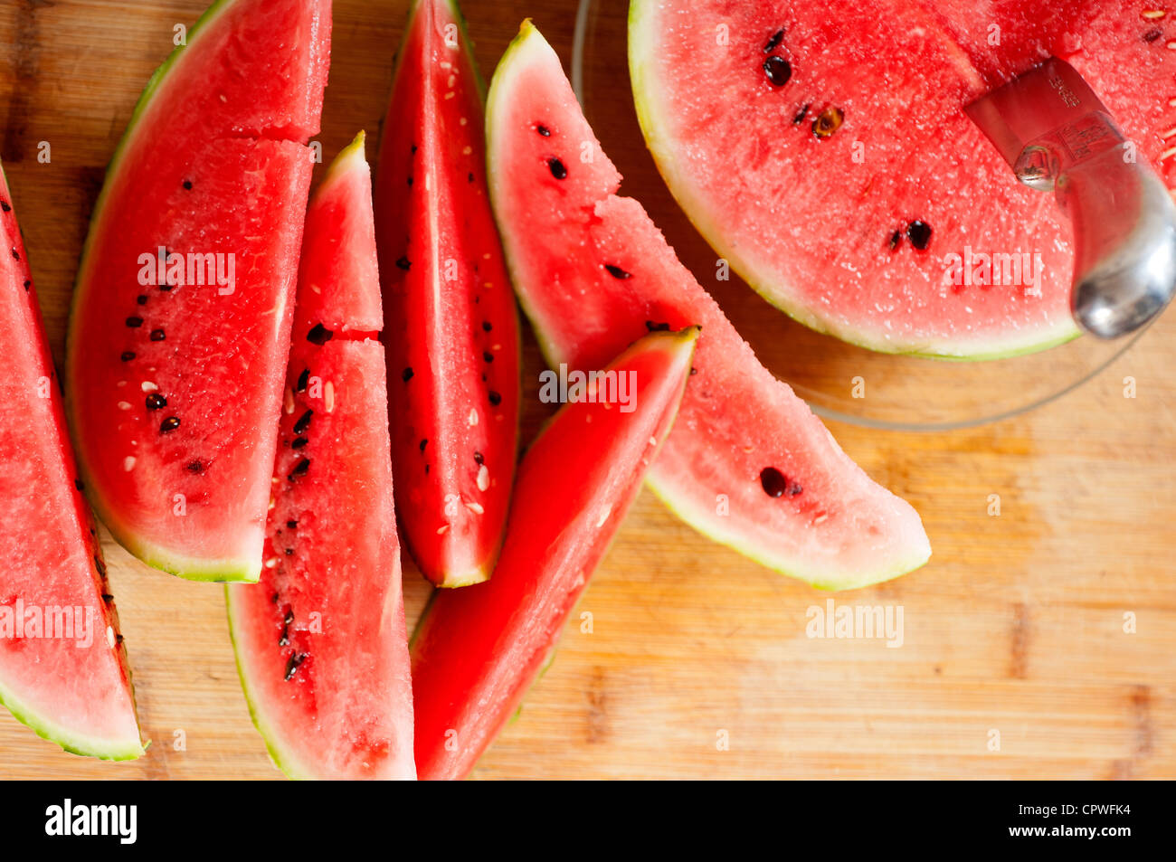fresh ripe watermelon sliced on a wood table Stock Photo - Alamy