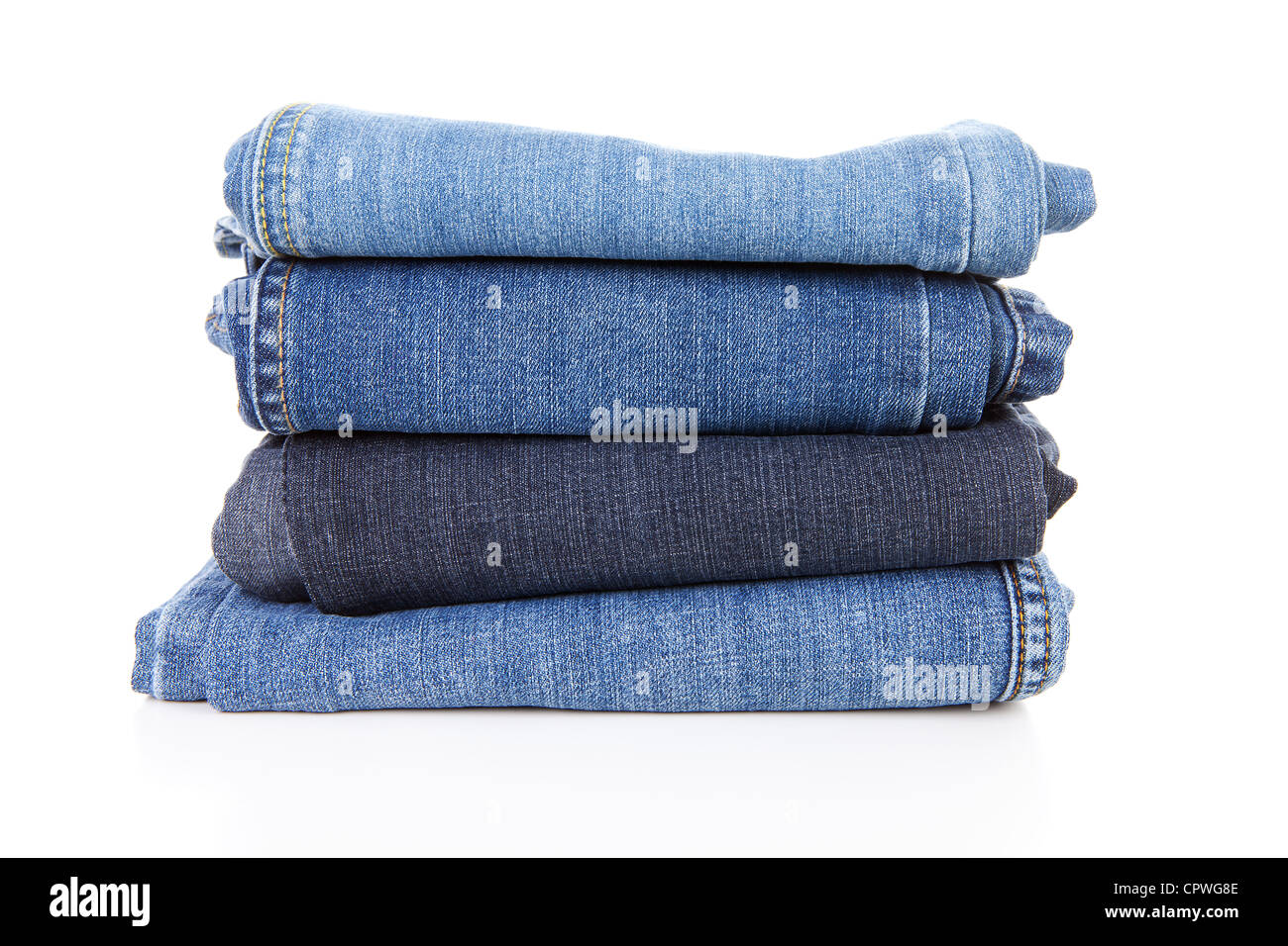 Pile of blue jeans over white background Stock Photo - Alamy