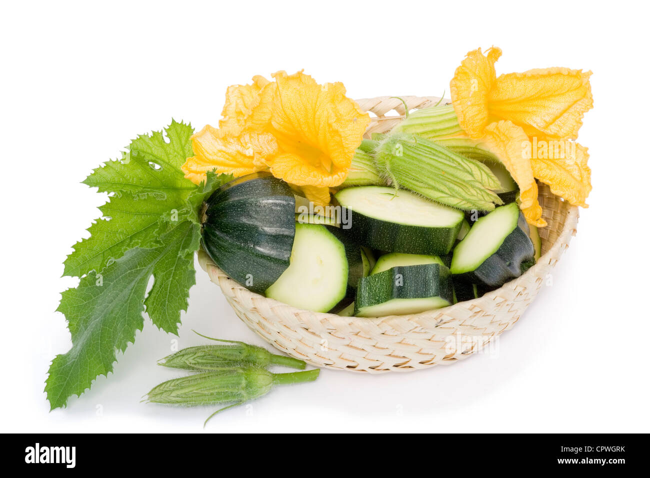 The vegetable marrow is cut on segments with flowerss, leaves in basket ...