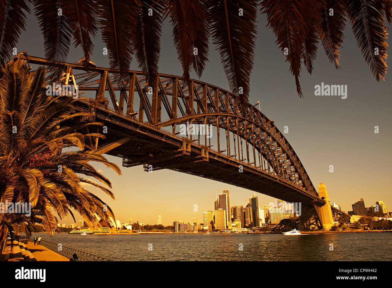 A golden view of Sydney Harbour Bridge spanning Sydney Harbour Stock ...