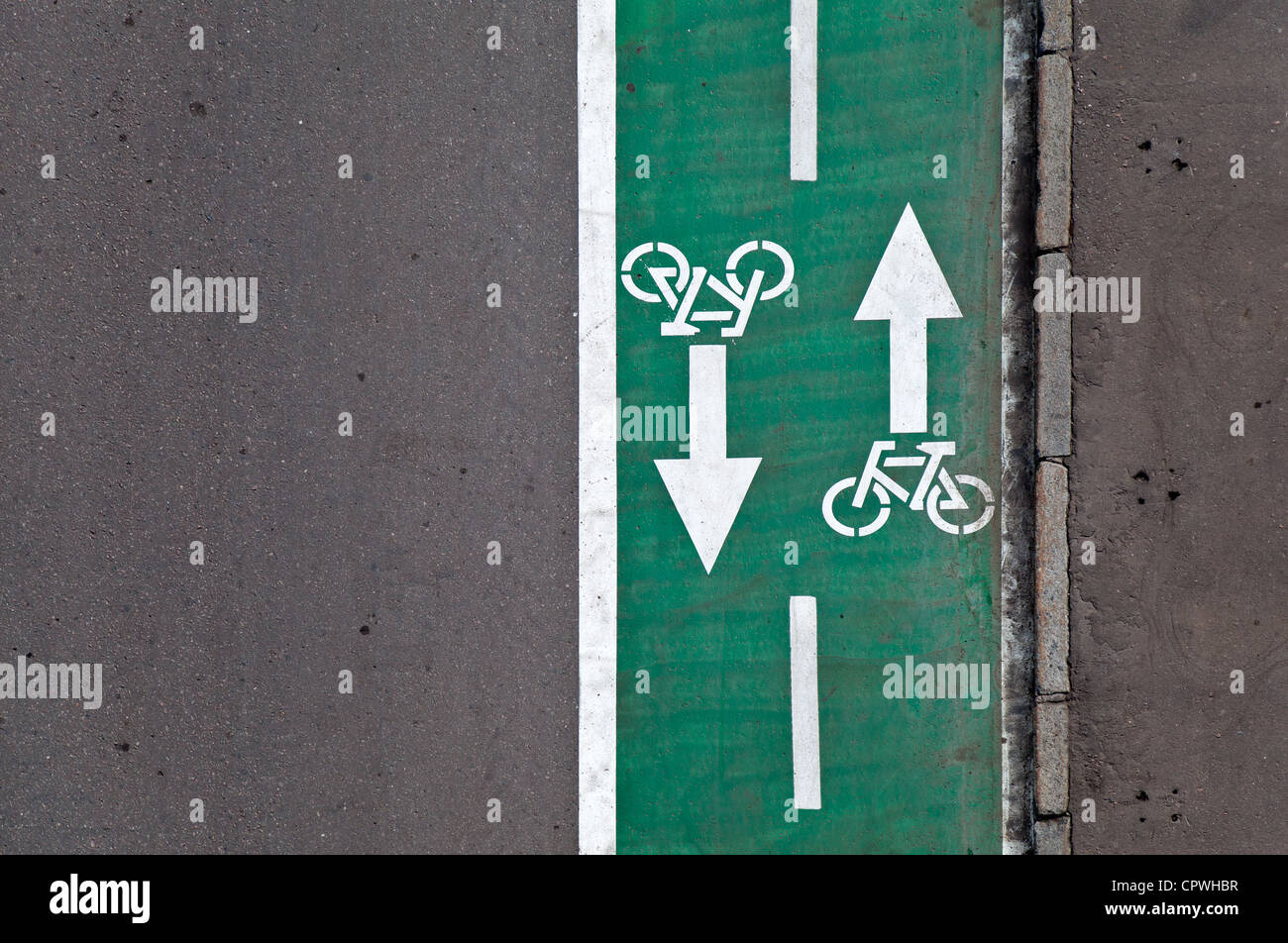 Green bicycle lane with road marking background texture Stock Photo - Alamy