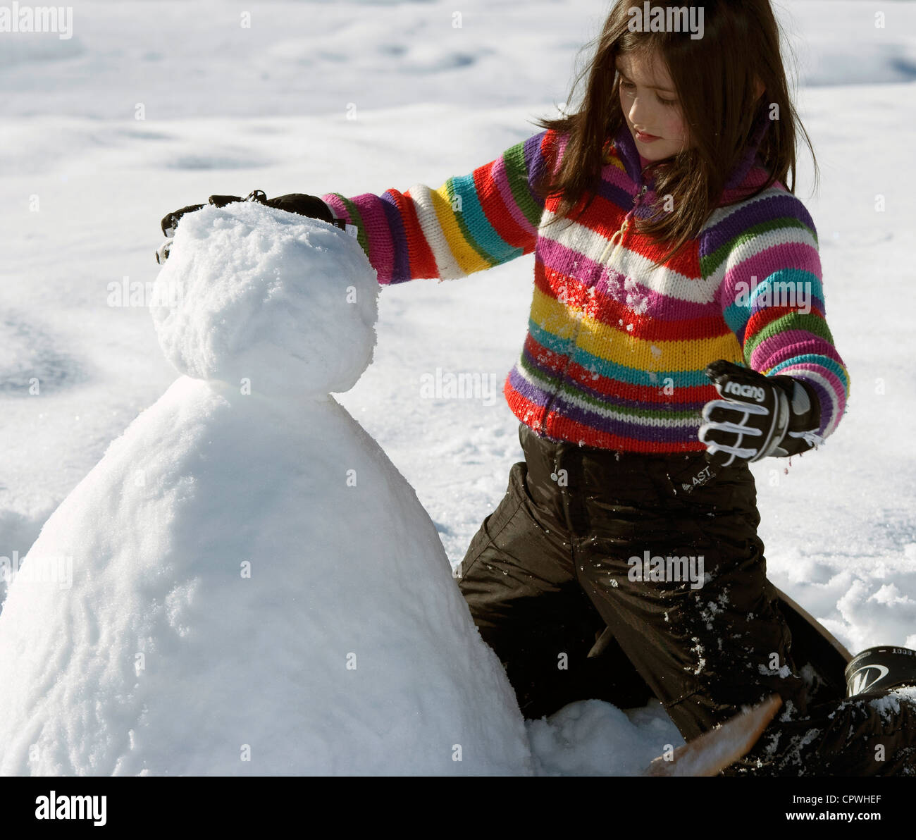 A cute young girl posing with her snowman Stock Photo - Alamy