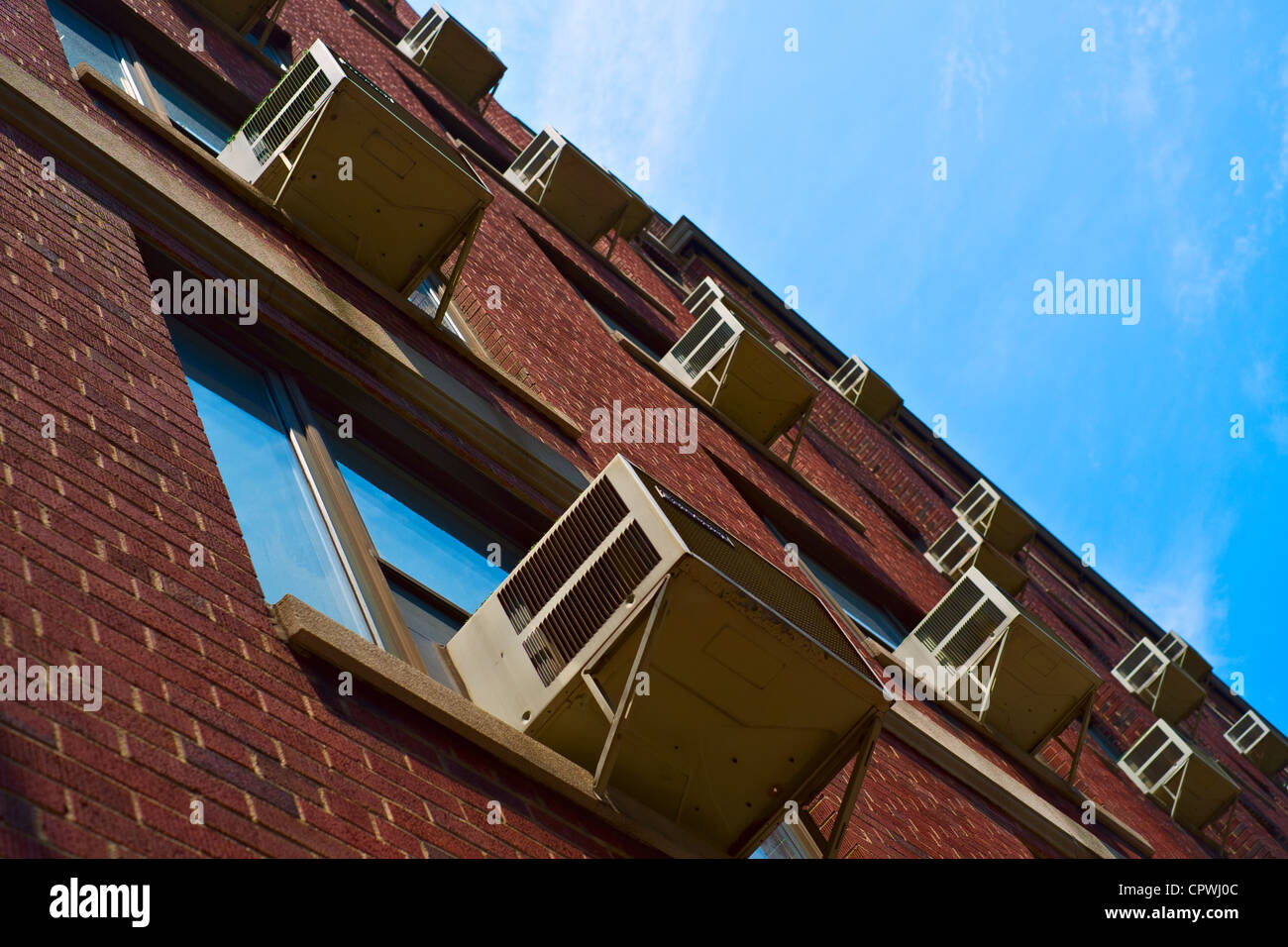Air conditioners in building windows Stock Photo - Alamy