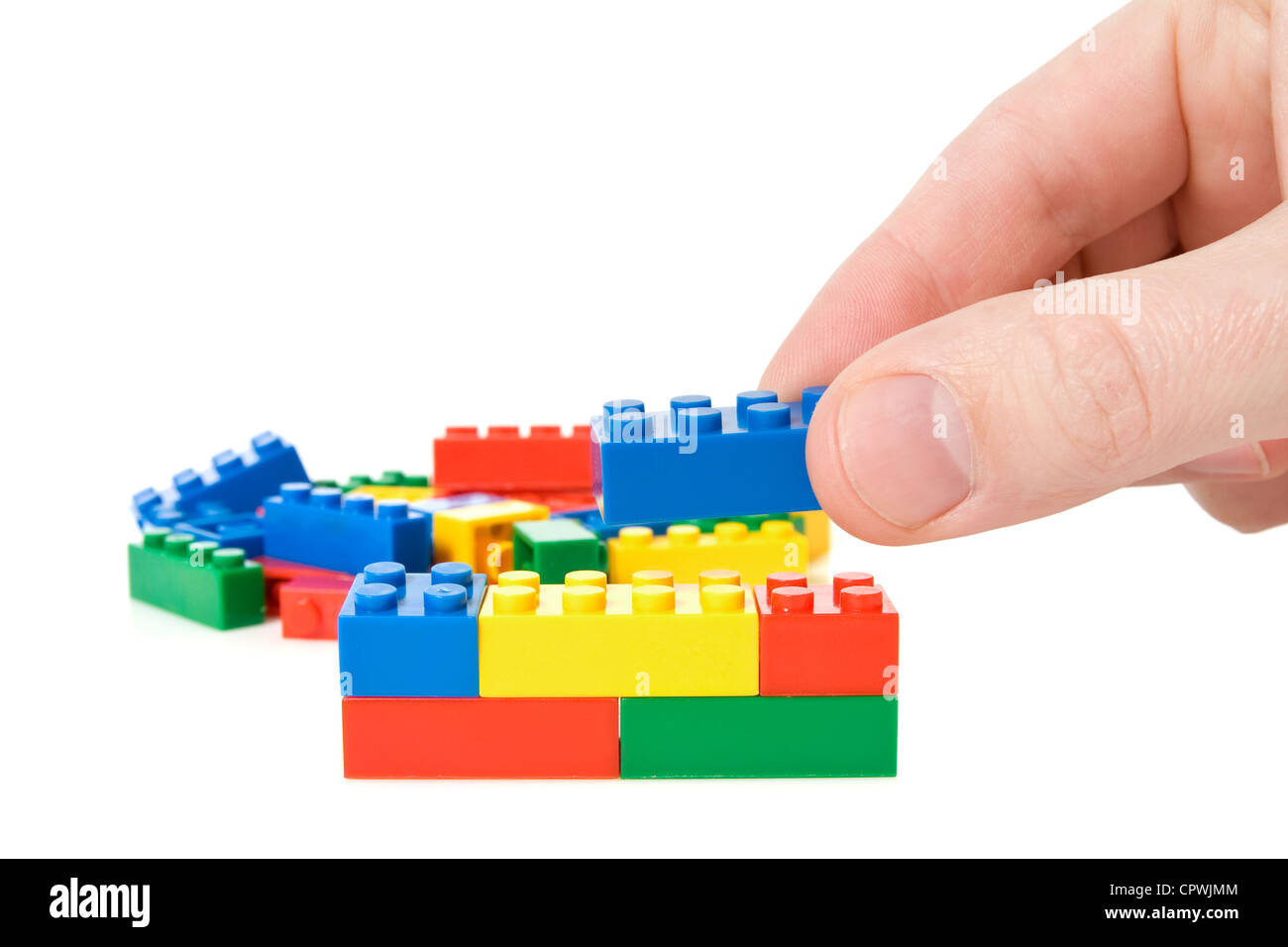 hand build a color plastic bricks. isolated on white Stock Photo - Alamy