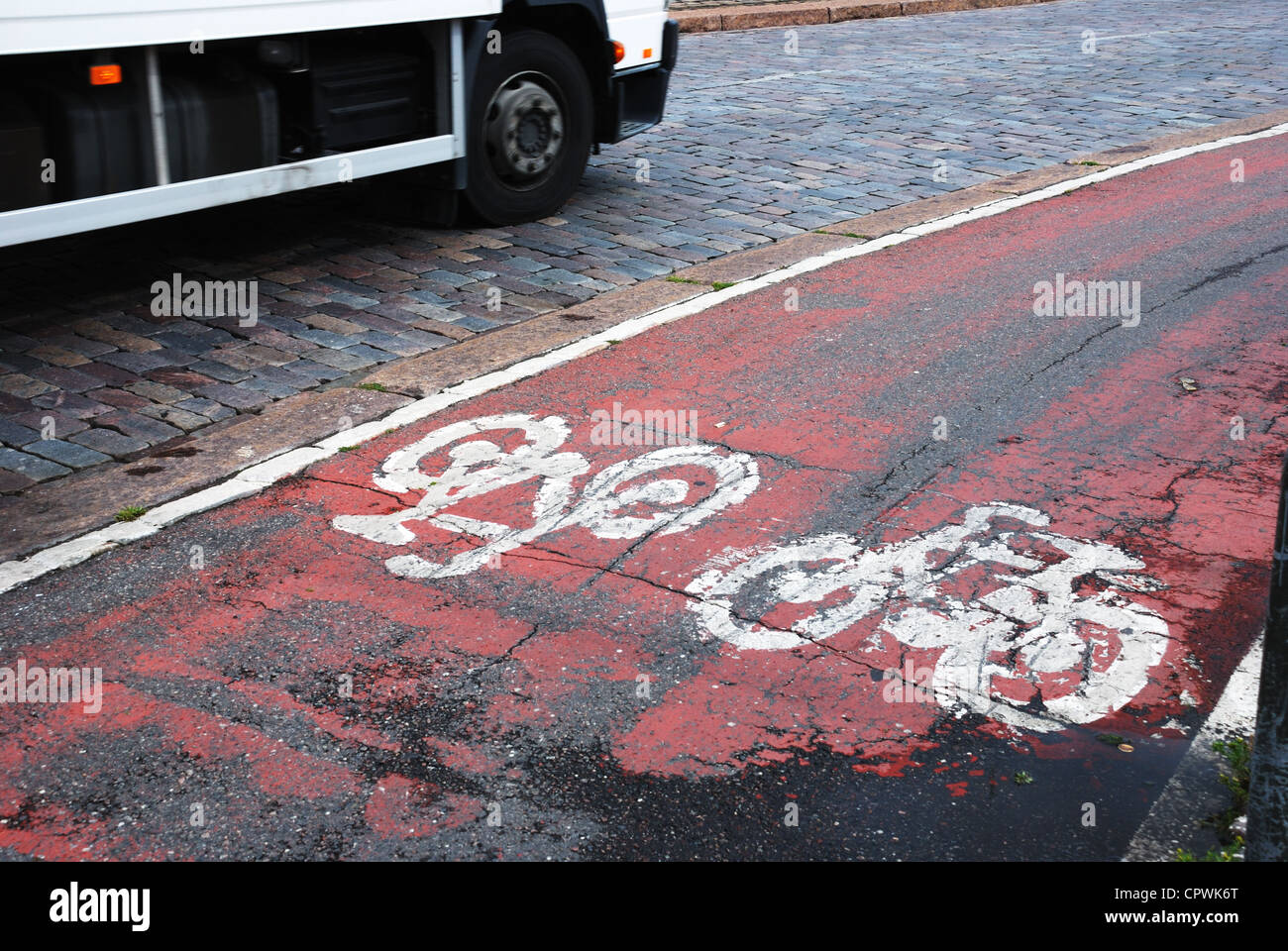 cycle path painted red with two white bike outlines Stock Photo - Alamy