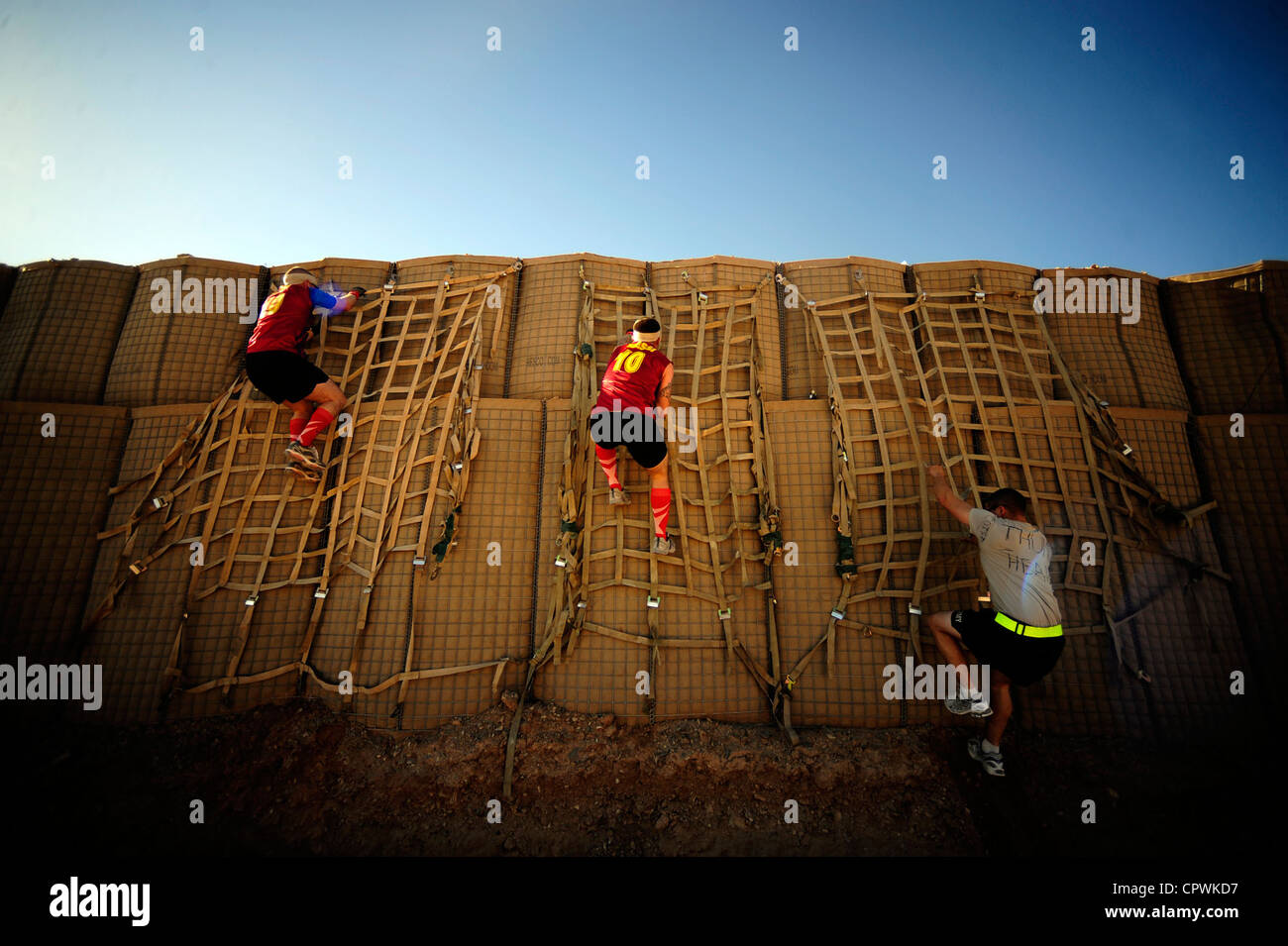 Participants from Forward Operating Base Farah climb a cargo net during ...