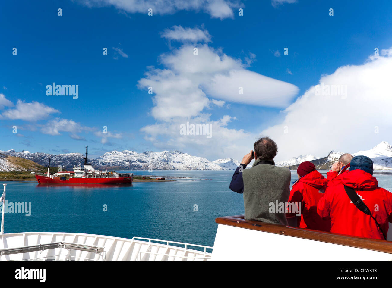 Expedition ship passengers on deck as the ship passes King Edward Point ...