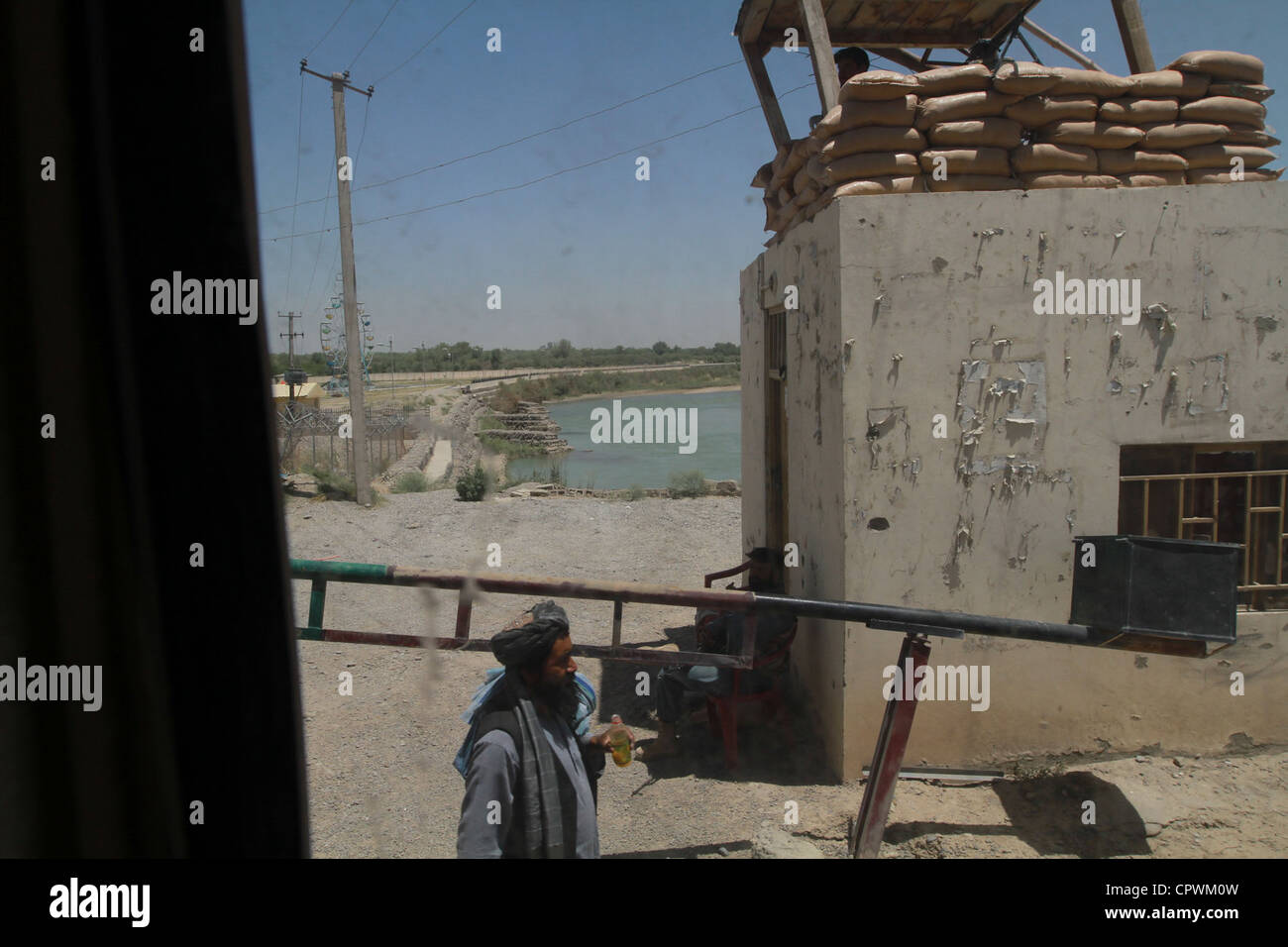 An Afghan man walks past an Afghan National Police checkpoint in ...