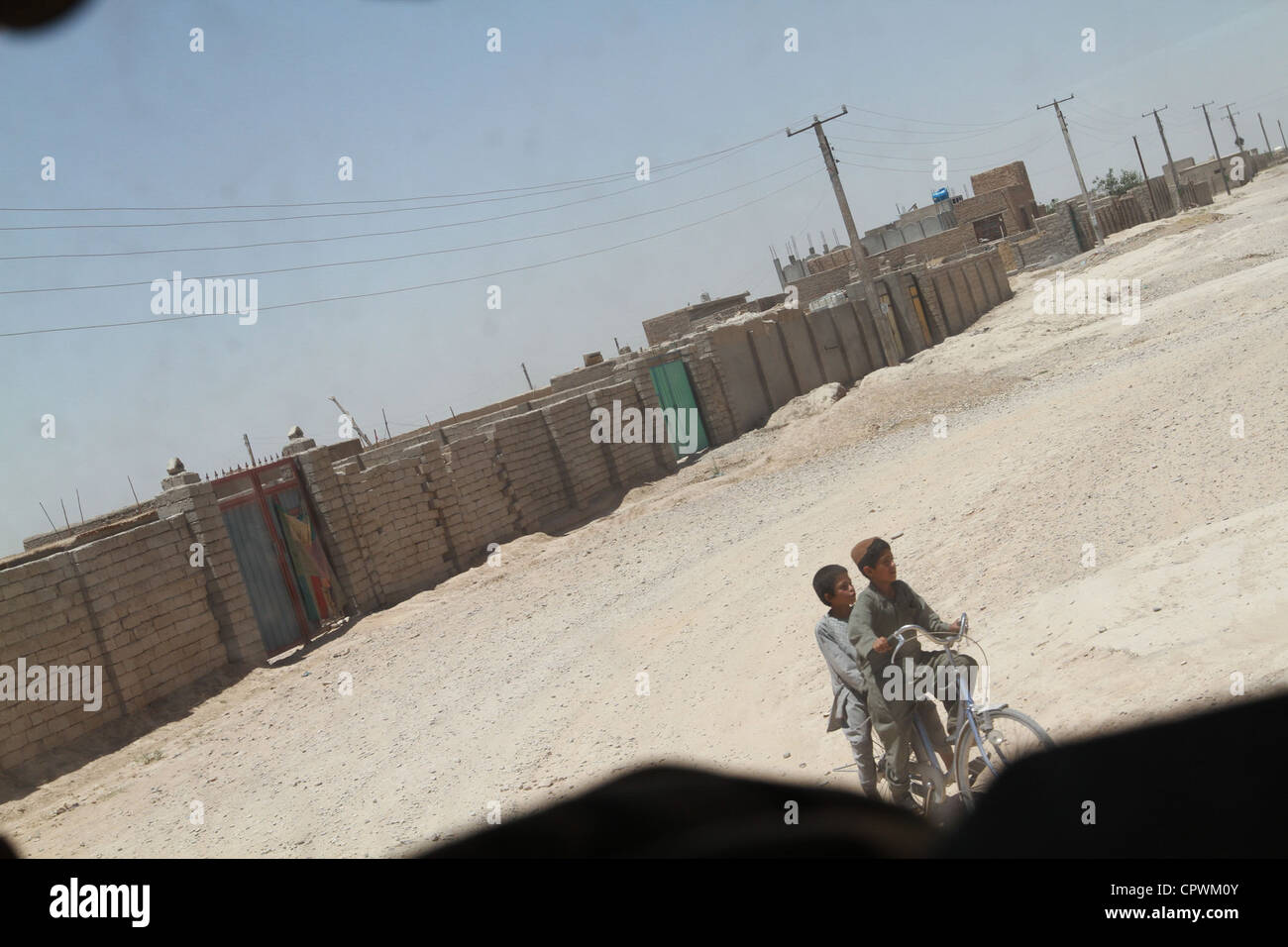 Afghan children ride a bicylce in Lashkar Gah, Helmand province ...