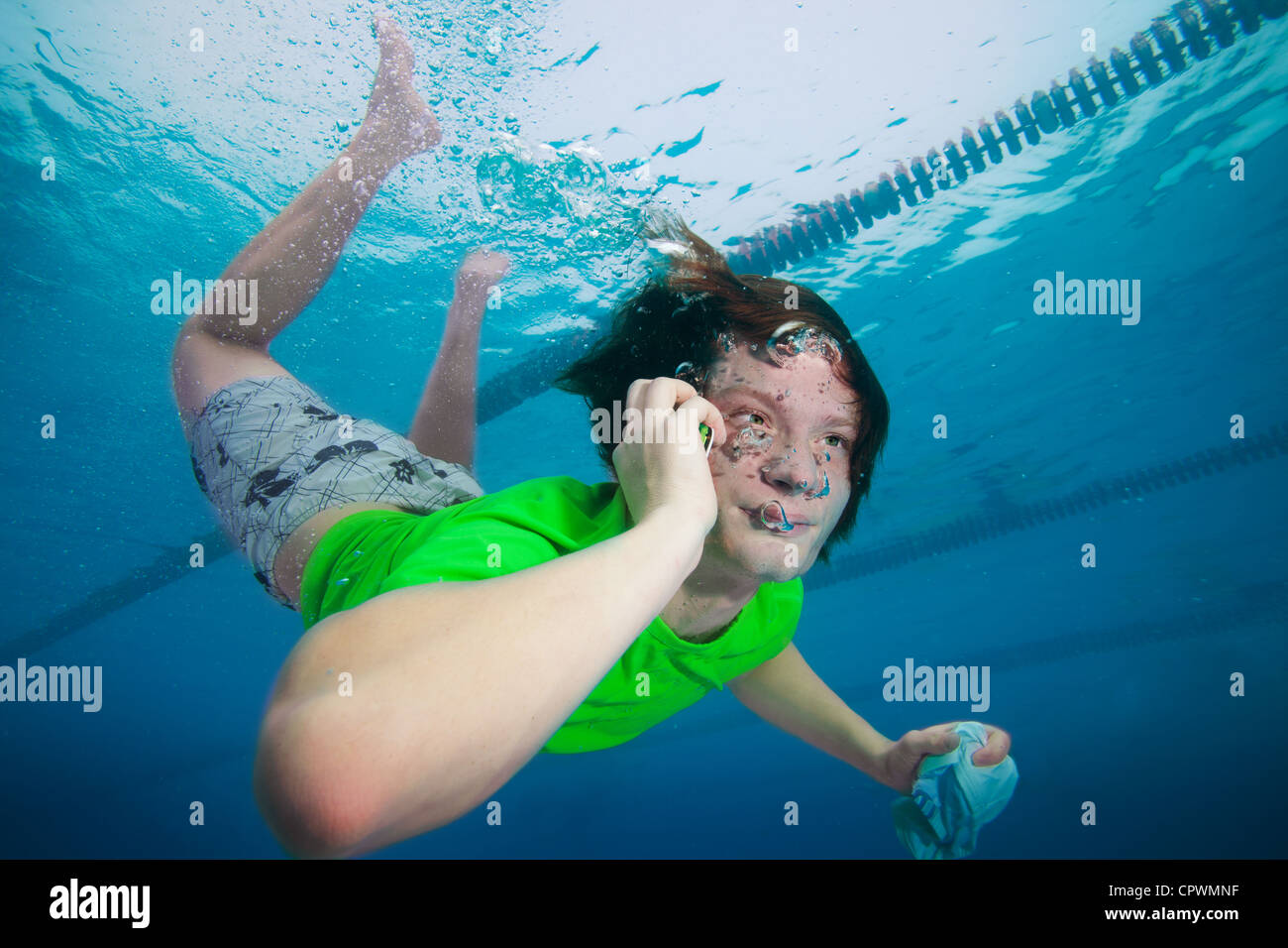 Man speaking on the cell phone underwater while swimming Stock Photo ...