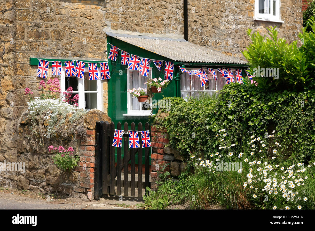 Union Jack flag Bunting bedecks a house in Dorset Stock Photo - Alamy