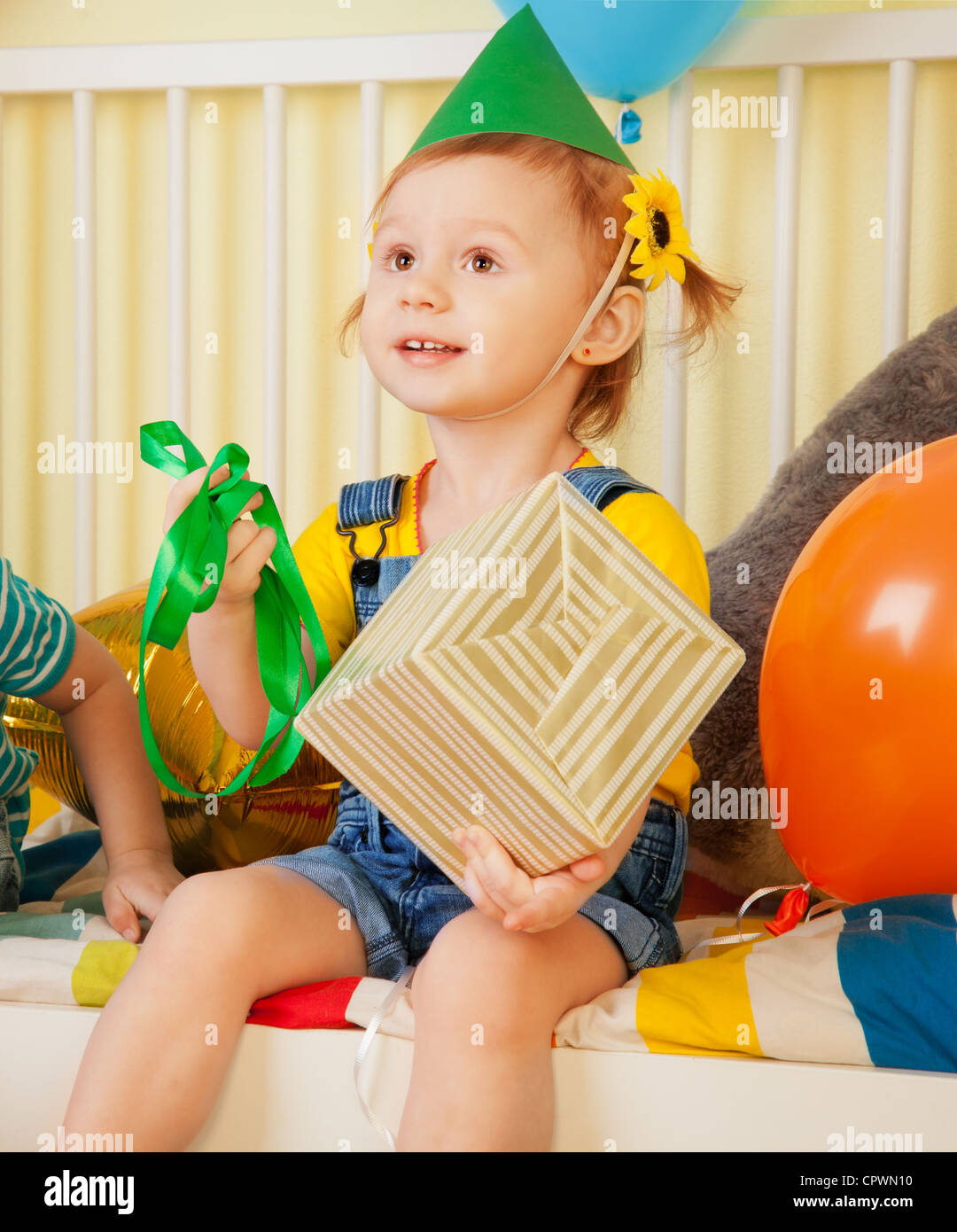 Little girl open the present on her birthday Stock Photo - Alamy