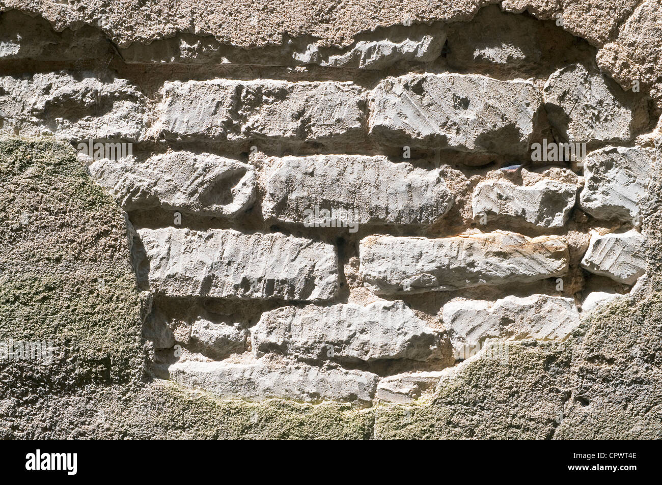 Old sand mortar rendering revealing brick wall - France Stock Photo - Alamy