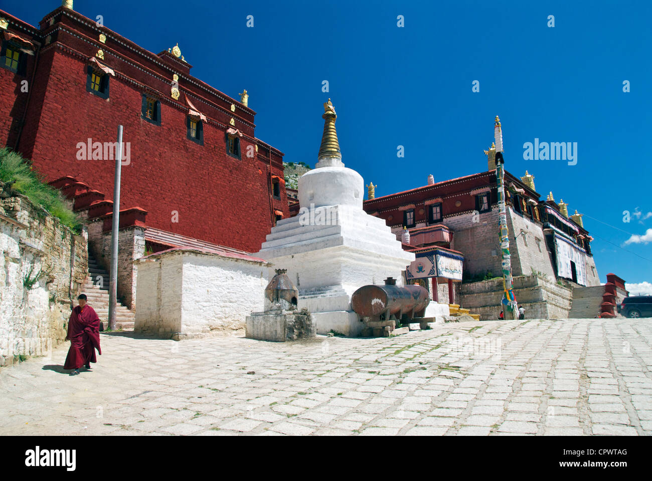 Ganden monastery courtyard and monk Stock Photo - Alamy