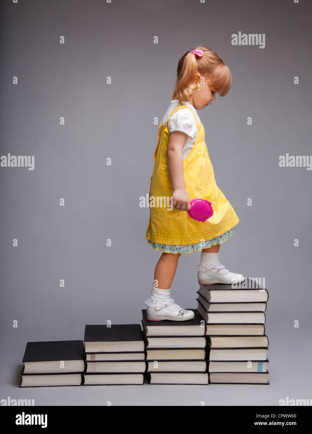 Climbing on the steps of books that symbolize education levels Stock ...