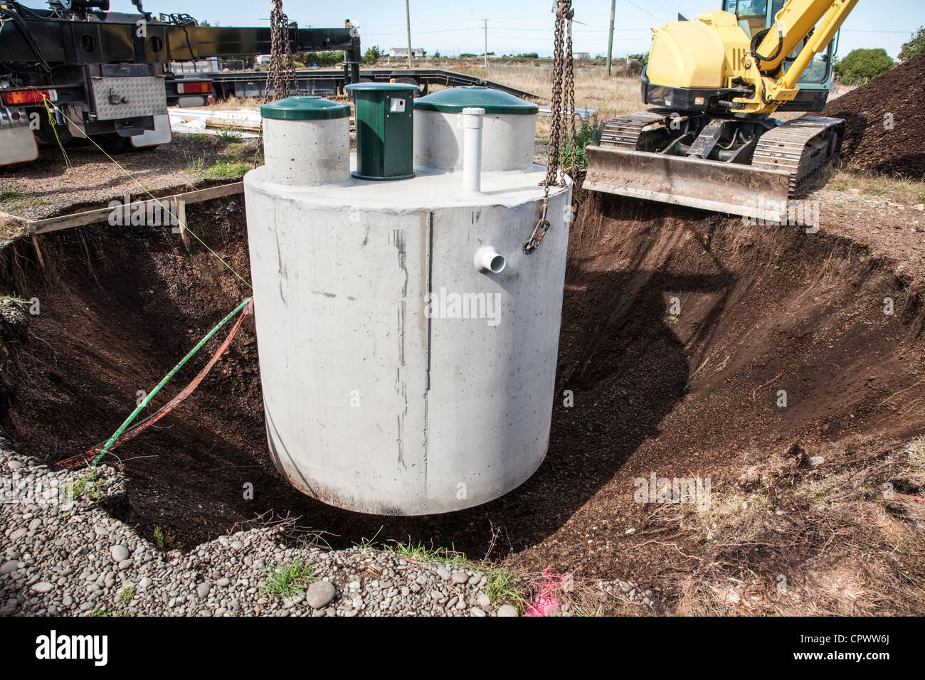 Environmentally friendly septic tank being lowered into ground Stock ...