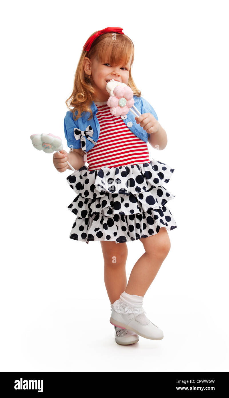 Happy girl standing and eating flower sweets, isolated on white Stock ...