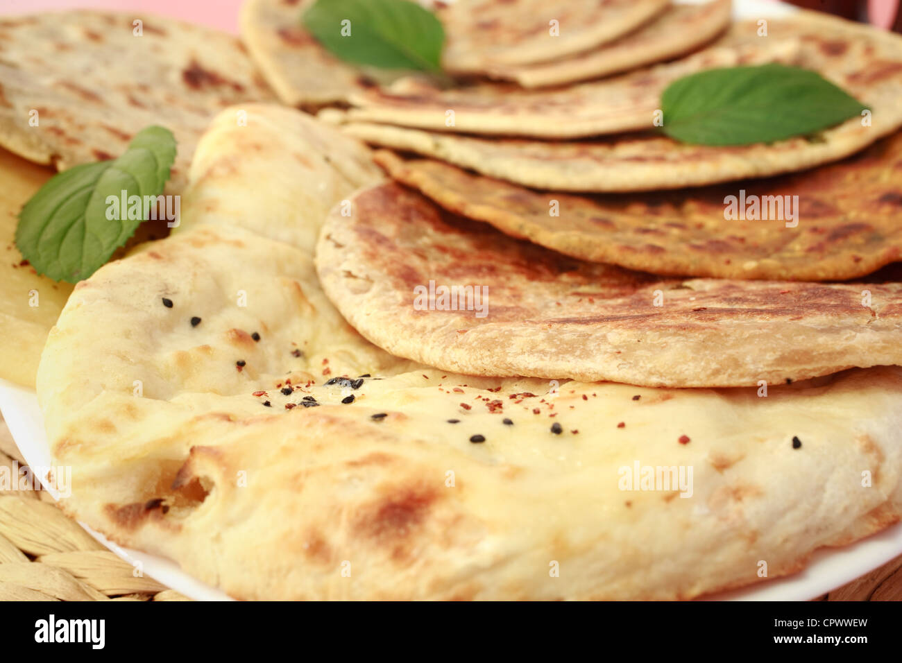 Selection of Indian breads, with naan in the foreground, and various ...
