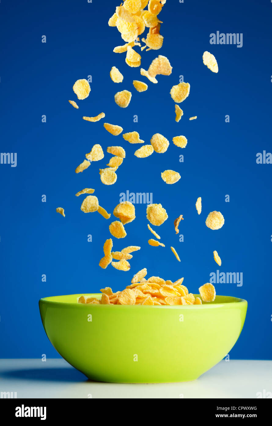 Corn flakes falling to the bowl for breakfast blue Stock Photo - Alamy