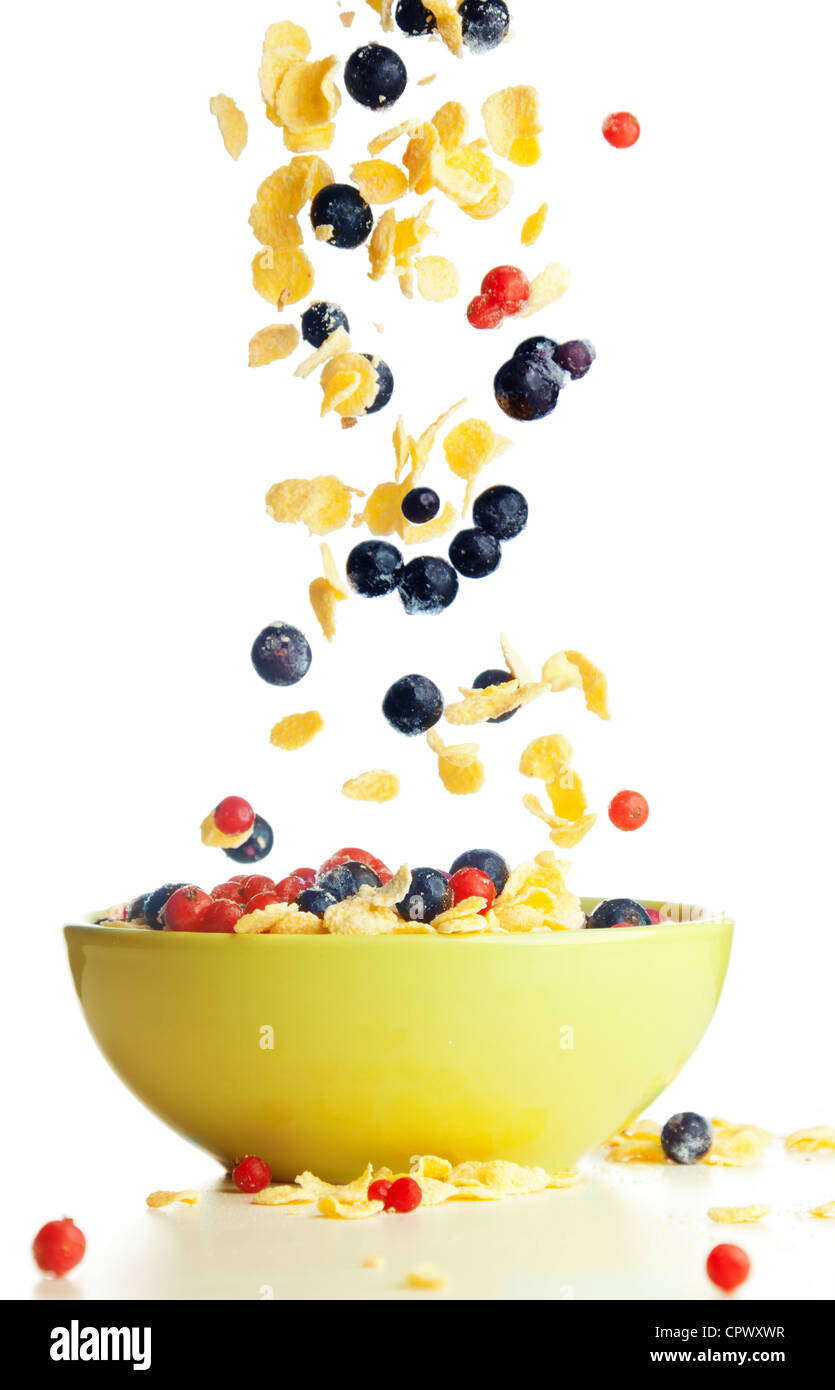 Flying to the bowl corn flakes with berries isolate on white Stock ...