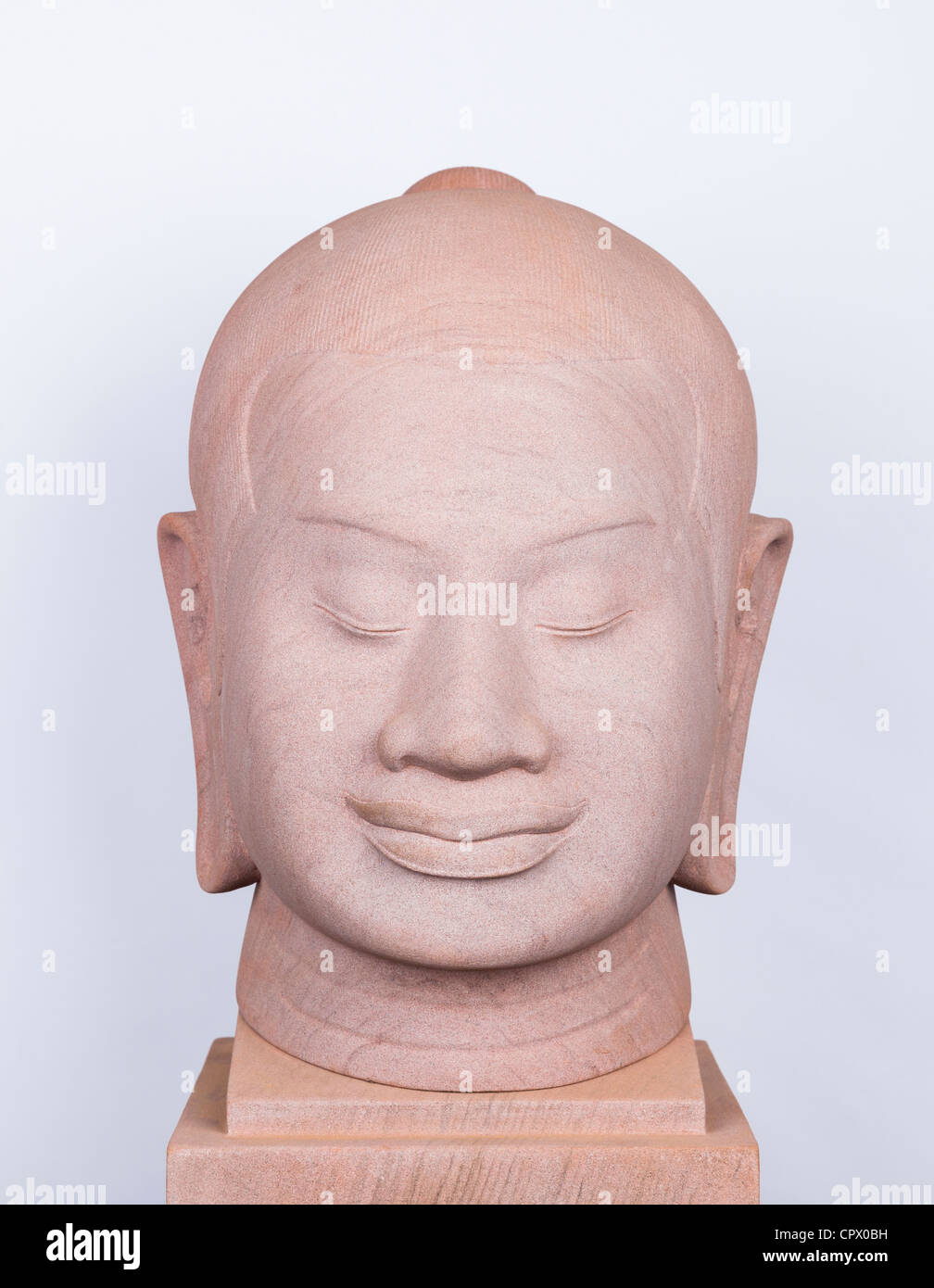 Sandstone head of the Khmer King Jayavarman VII against white ...