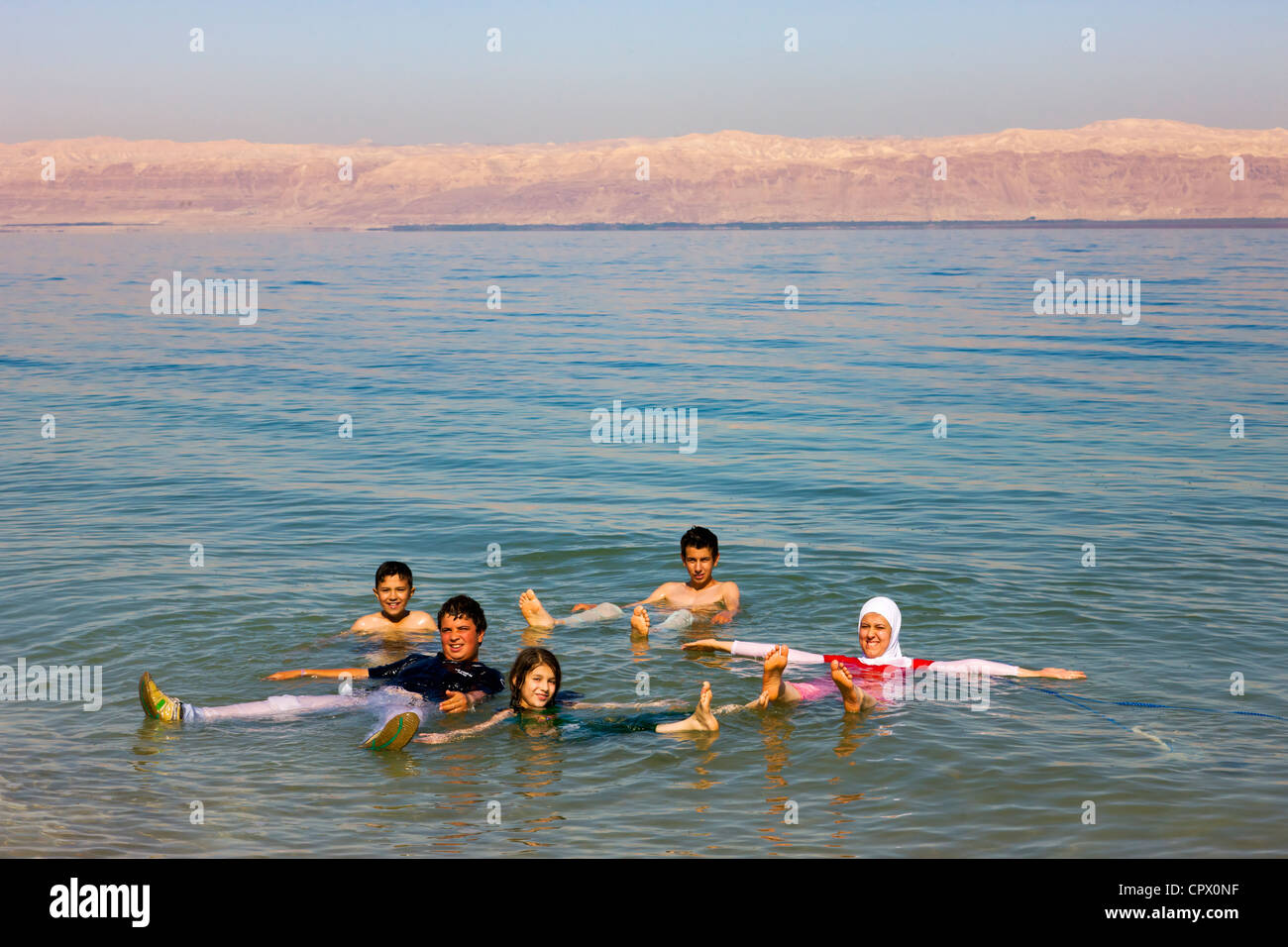Tourists floating in Dead Sea, Jordan Stock Photo - Alamy
