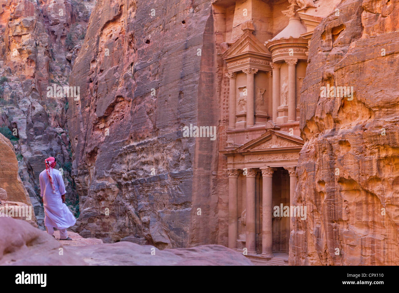 Arab man watching Facade of Treasury (Al Khazneh), Petra, Jordan ...