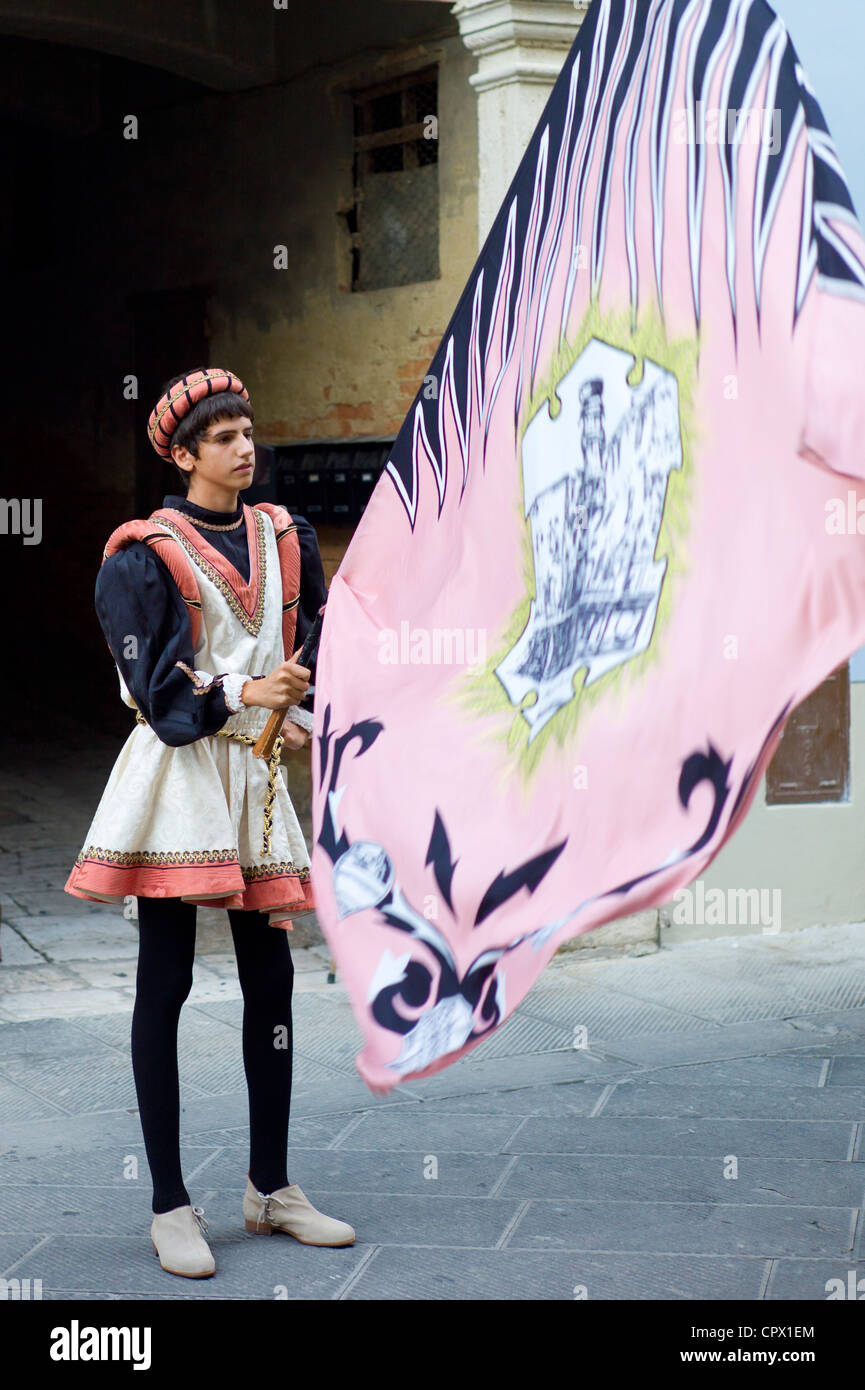 Contrada young man in livery costume at traditional parade in Asciano ...